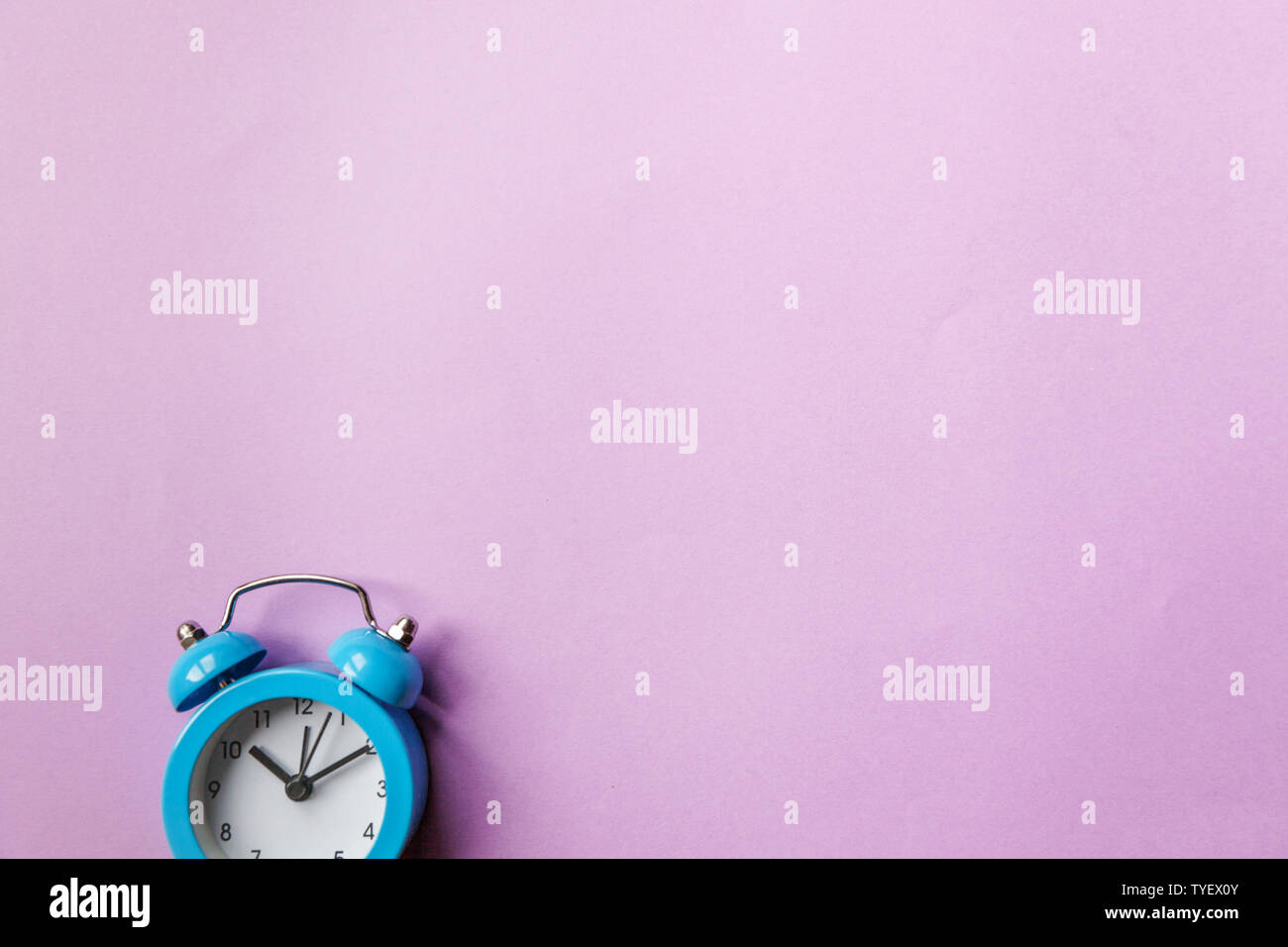 Ringing twin bell vintage classic alarm clock Isolated on purple violet ...