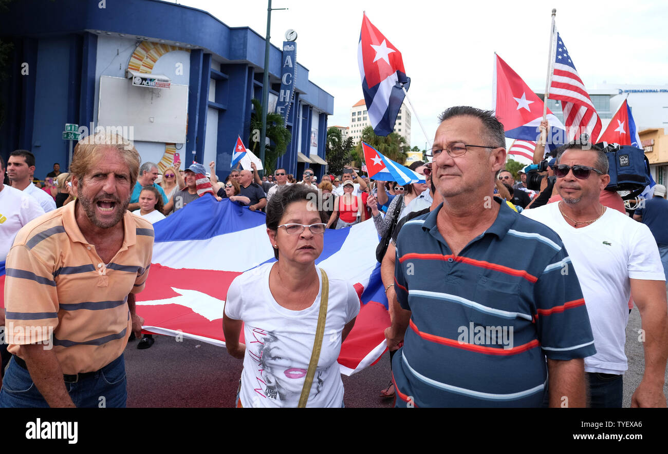 Cuban-Americans carry a large cuban flag during the celebration of the ...