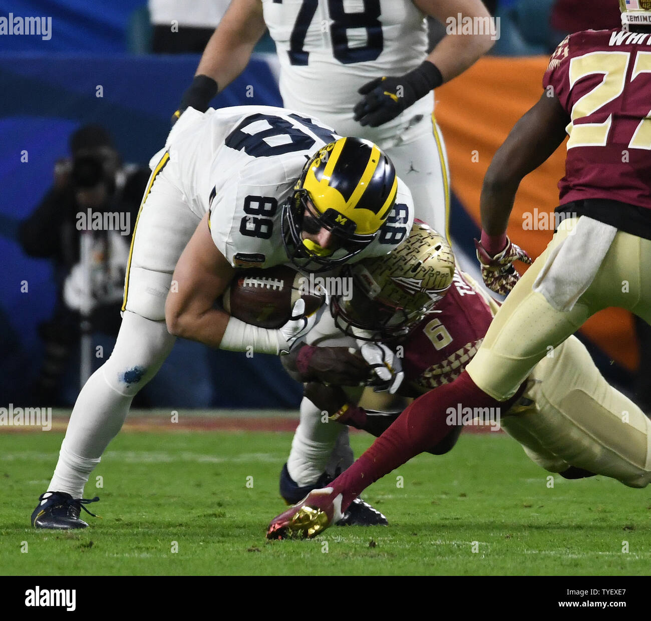 Florida State Seminoles LB Mathew Thomas tackles Michigan Wolverines WR ...