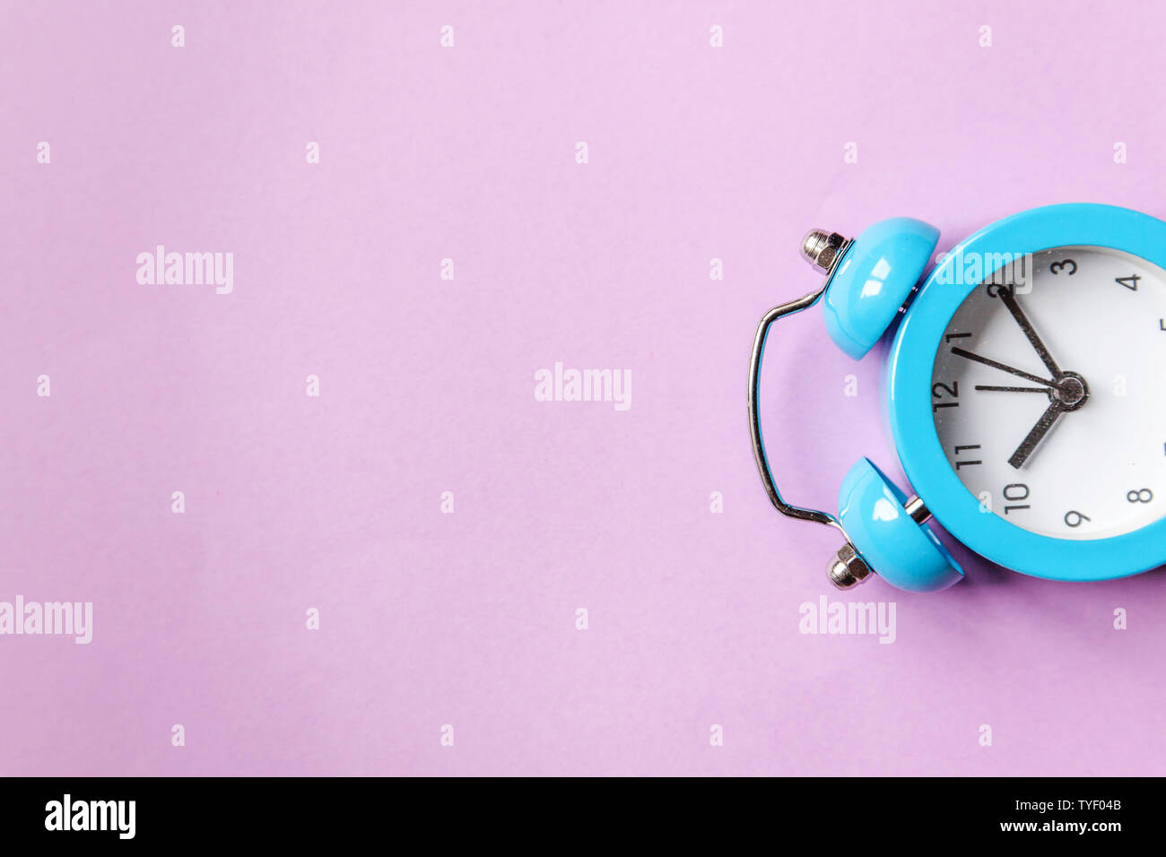 Ringing twin bell vintage classic alarm clock Isolated on purple violet ...