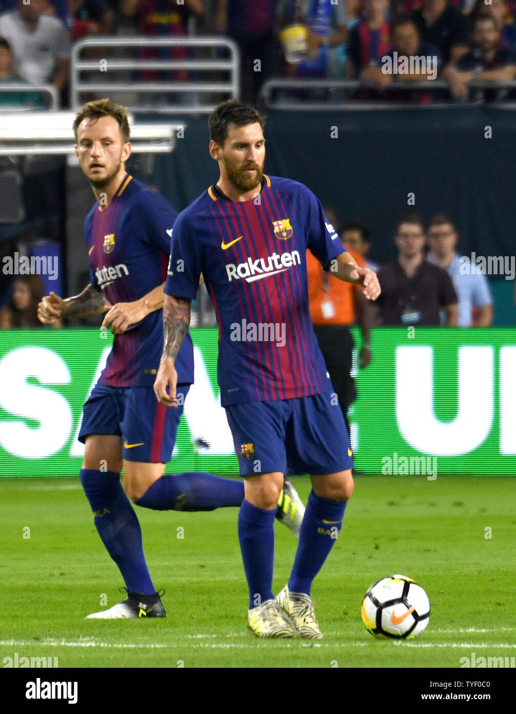 Barcelona's Lionel Messi (10) dribbles the ball against Real Madrid in ...