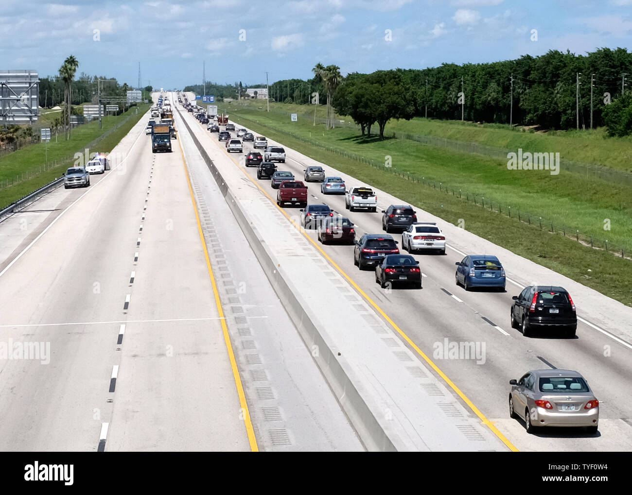 Vehicles move north (R) on the Florida Turnpike from the Keys and Miami ...