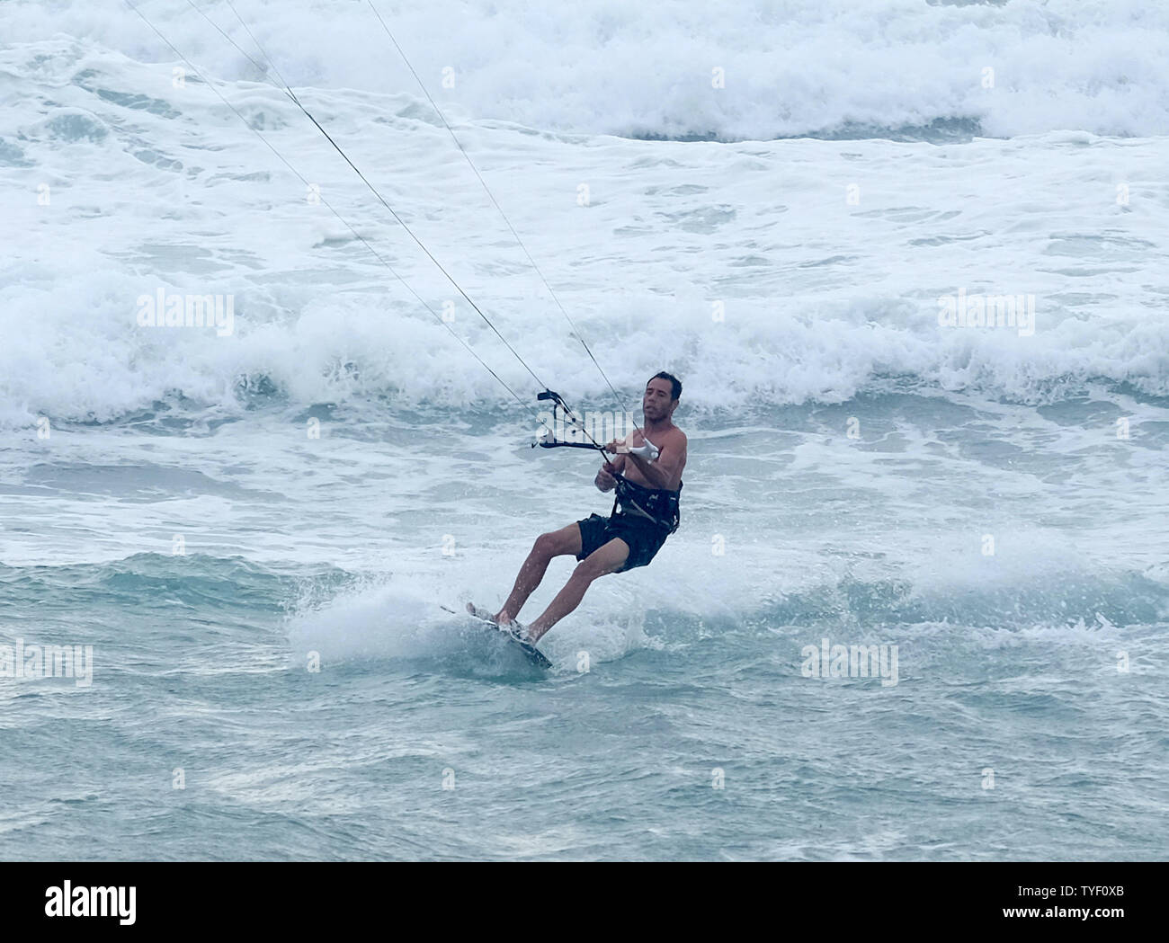 A kite surfer rides the waves in the Atlantic ocean as Hurricane Irma ...