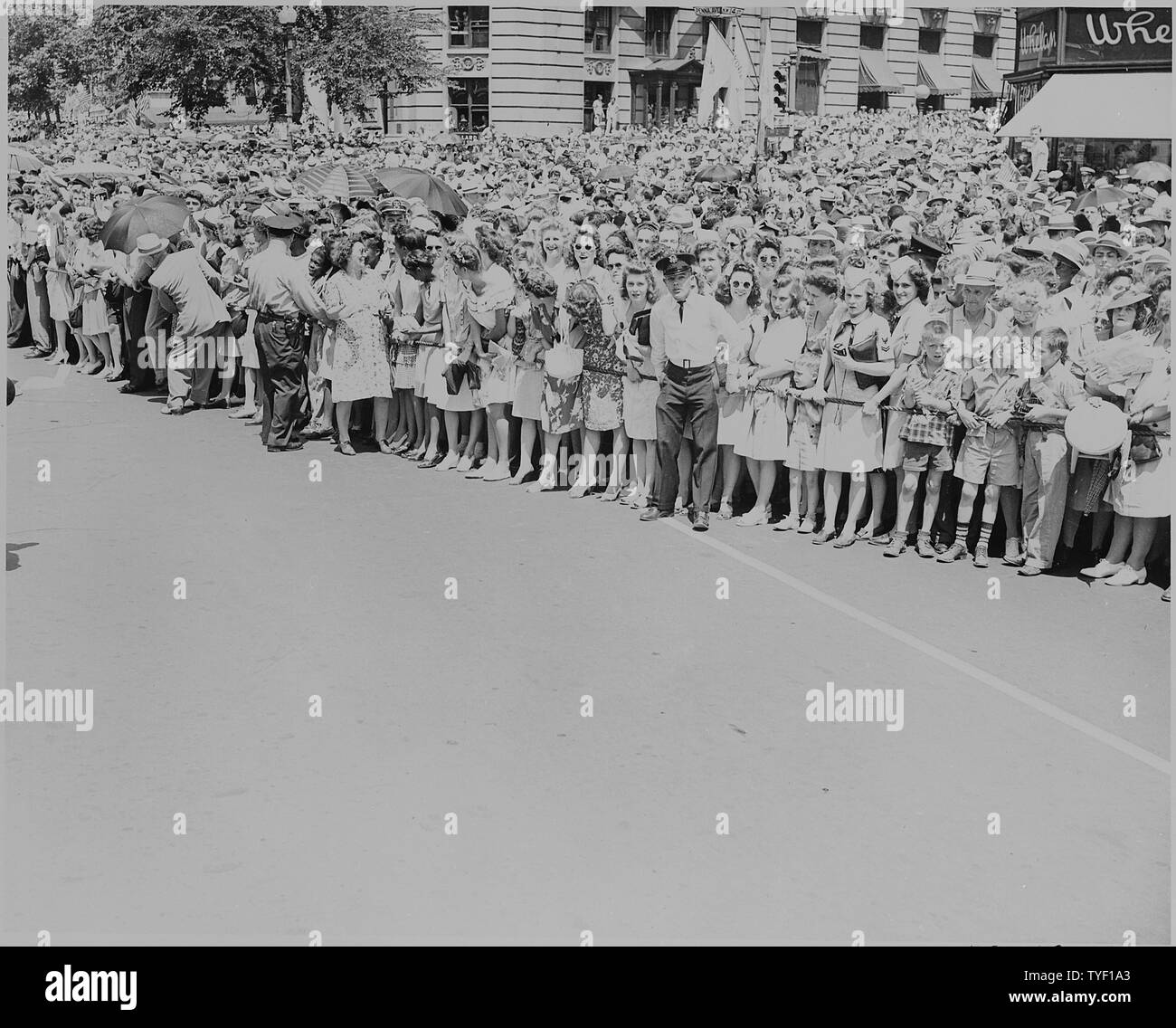 Photograph of police holding back crowds gathered along a Washington ...
