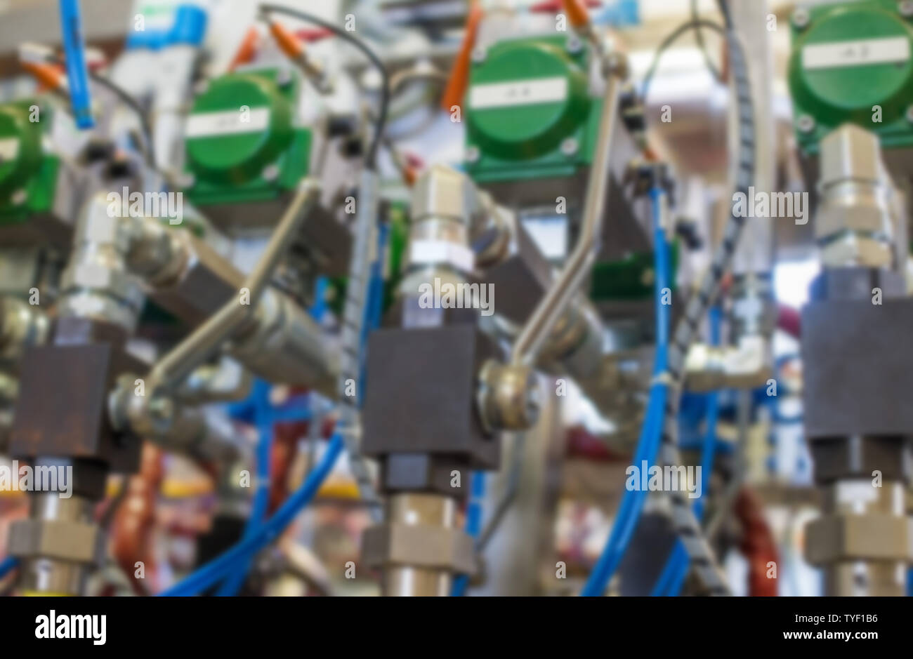 Blurred engineering background. Industrial system of pipes and valves ...