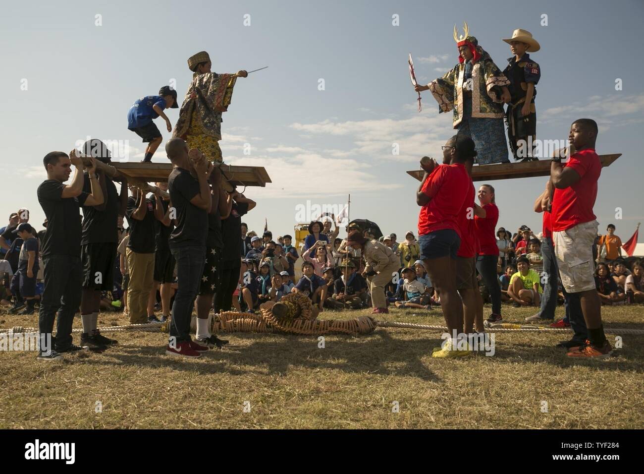 Scouts from Scout Association of Japan stand on platforms carried by ...