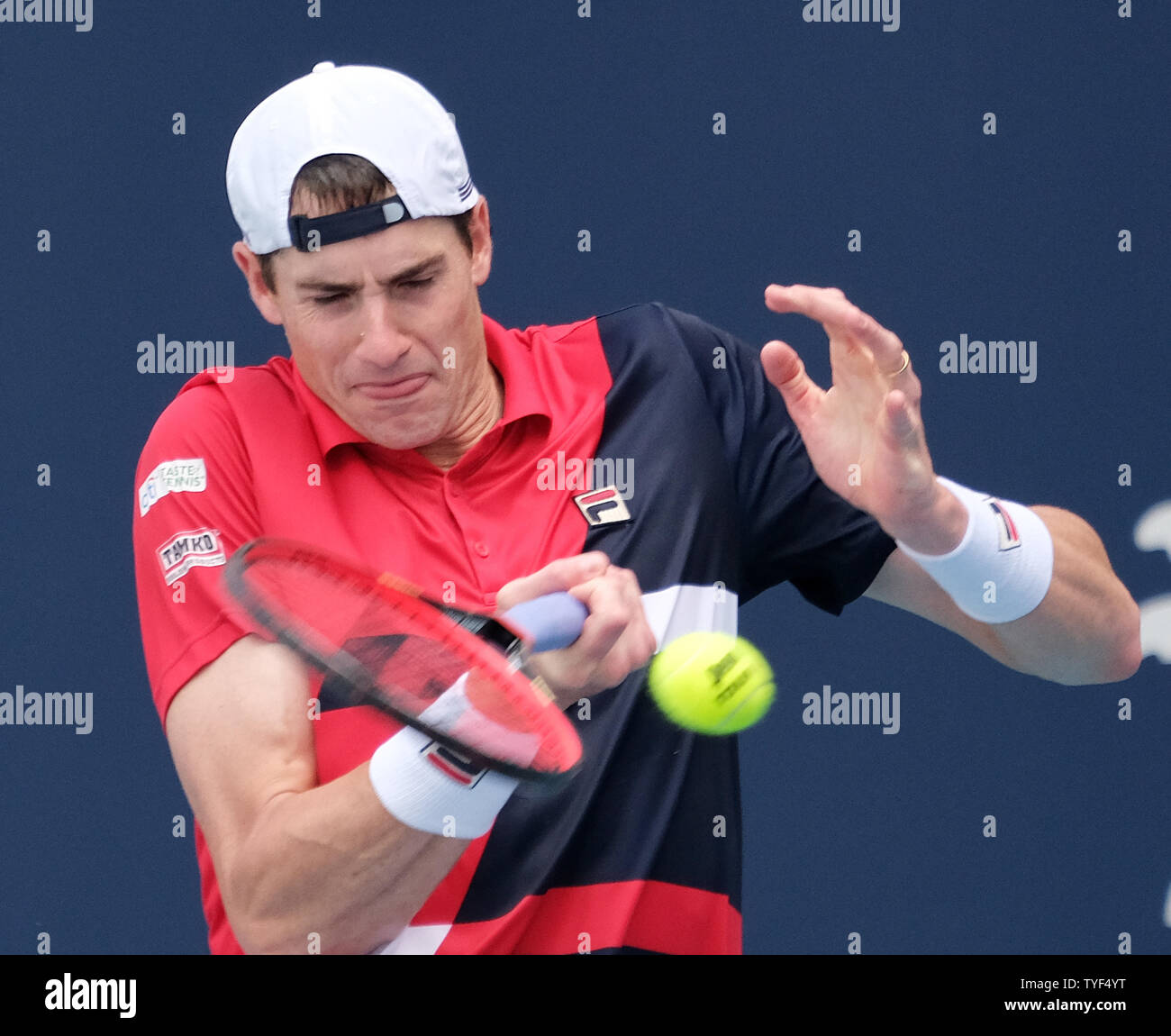 John Isner from the USA returns serve to Felix Auger-Aliassime from ...