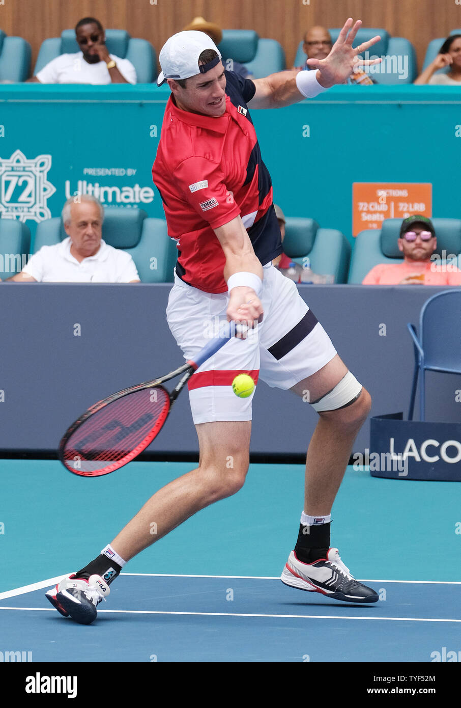 John Isner from the USA returns a forehand shot to Roger Federer from ...