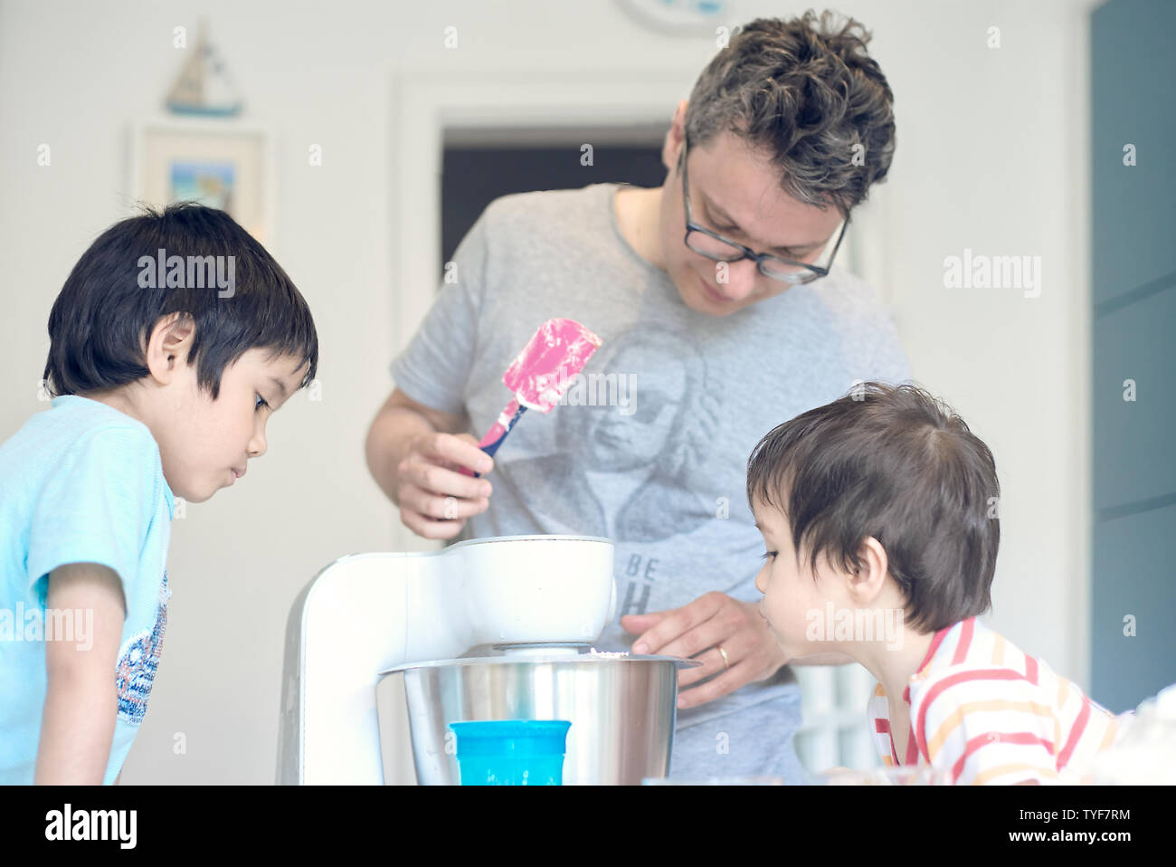 Dad baking with his two young sons Stock Photo - Alamy