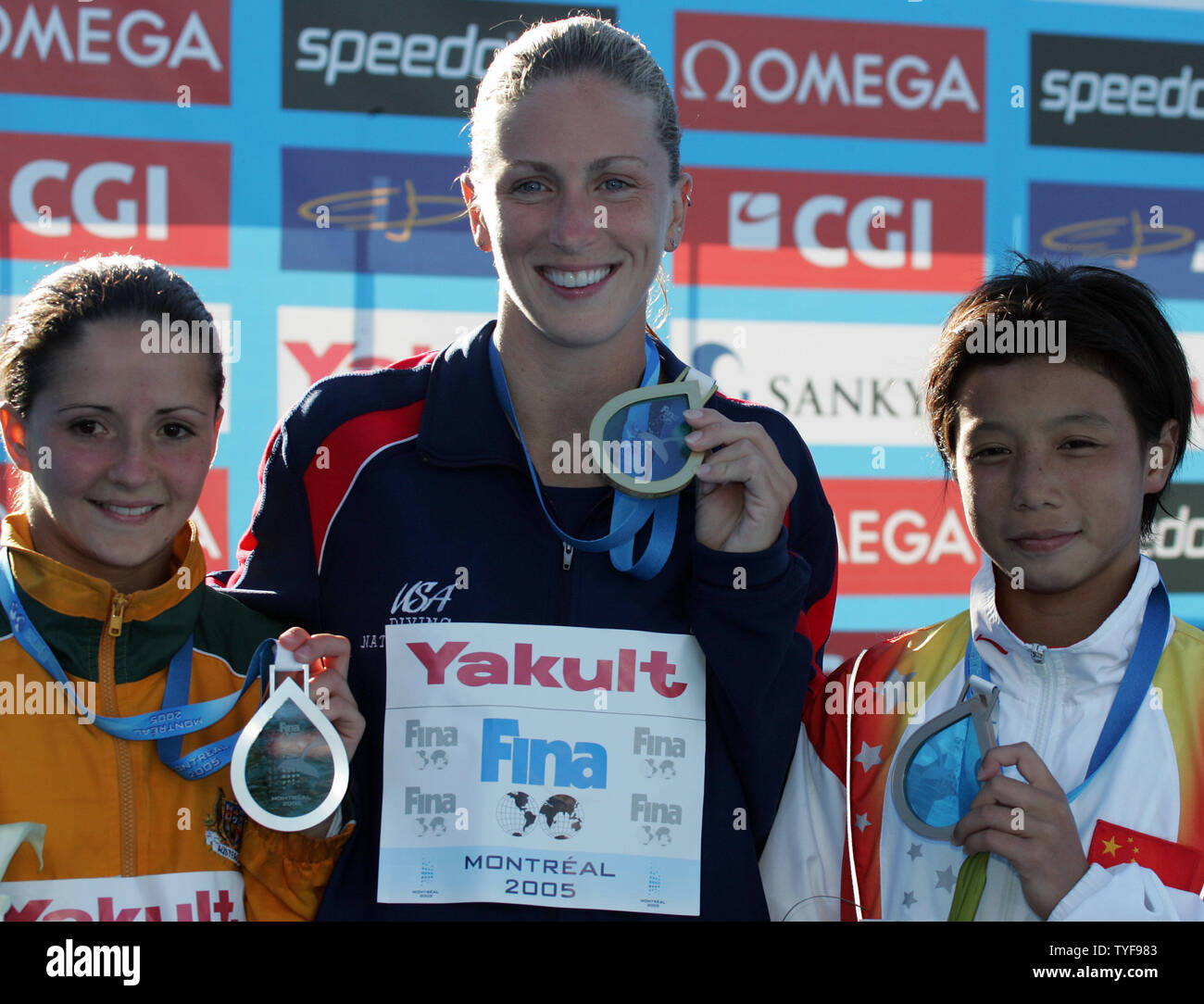 American diver Laura Wilkinson (center), of Spring, Tex., brandishes ...