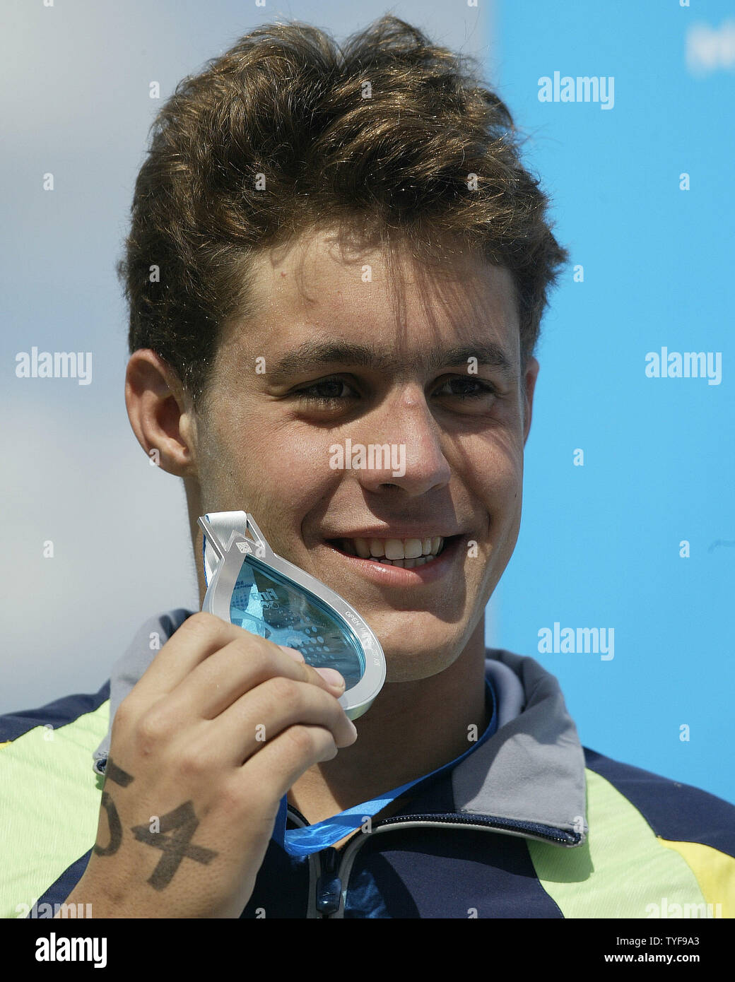 Australian distance swimmer Brendan Capell shows off his silver medal ...