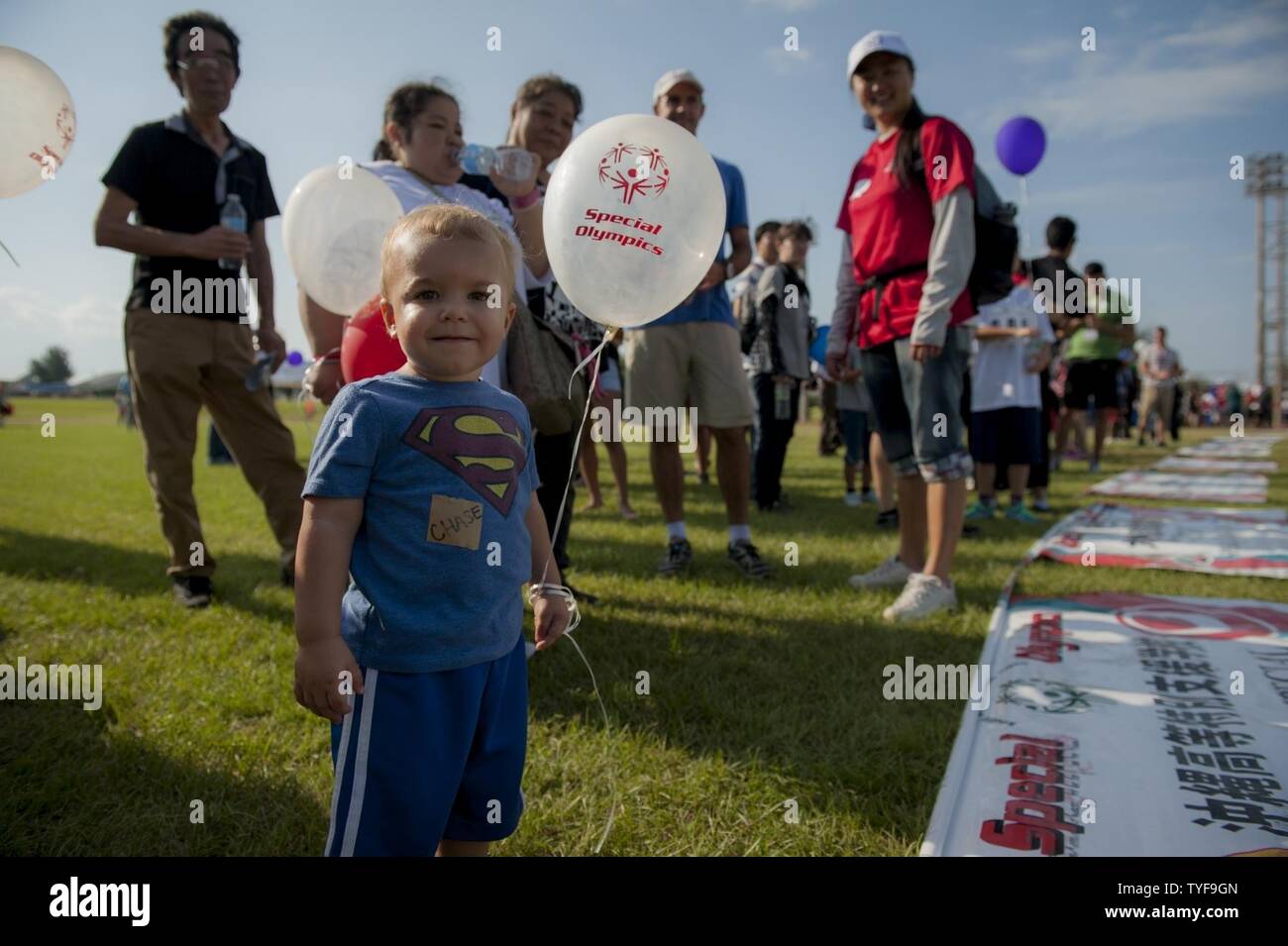 Chase, Brave Buddy helper, waits with athletes and family members for ...