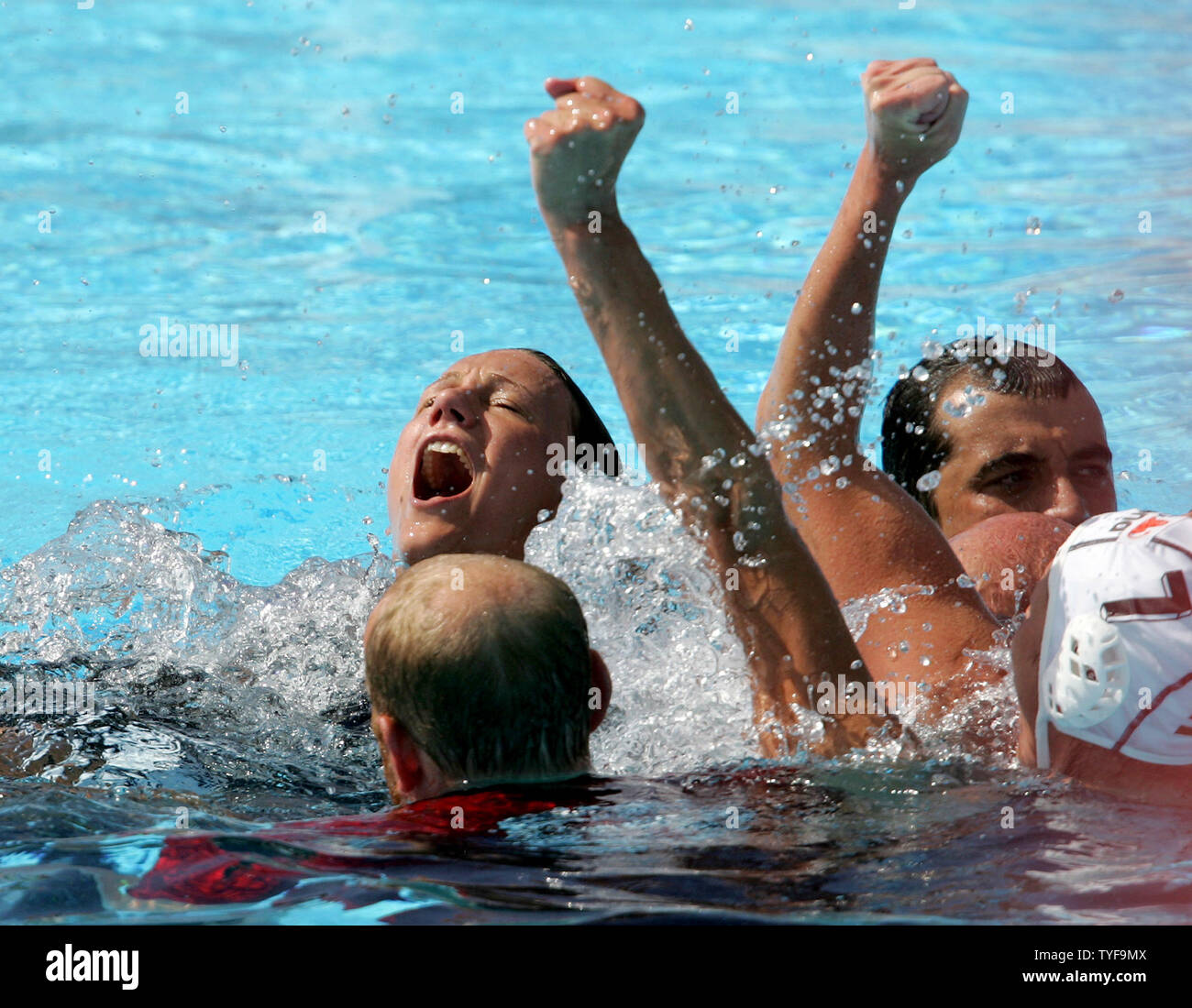 The Hungarian team coaches join their players in the pool to celebrate ...