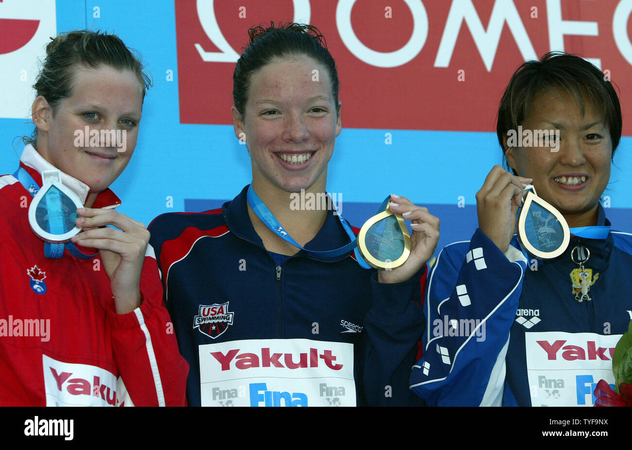 American swimmer Kate Ziegler (center) brandishes her gold medal from ...