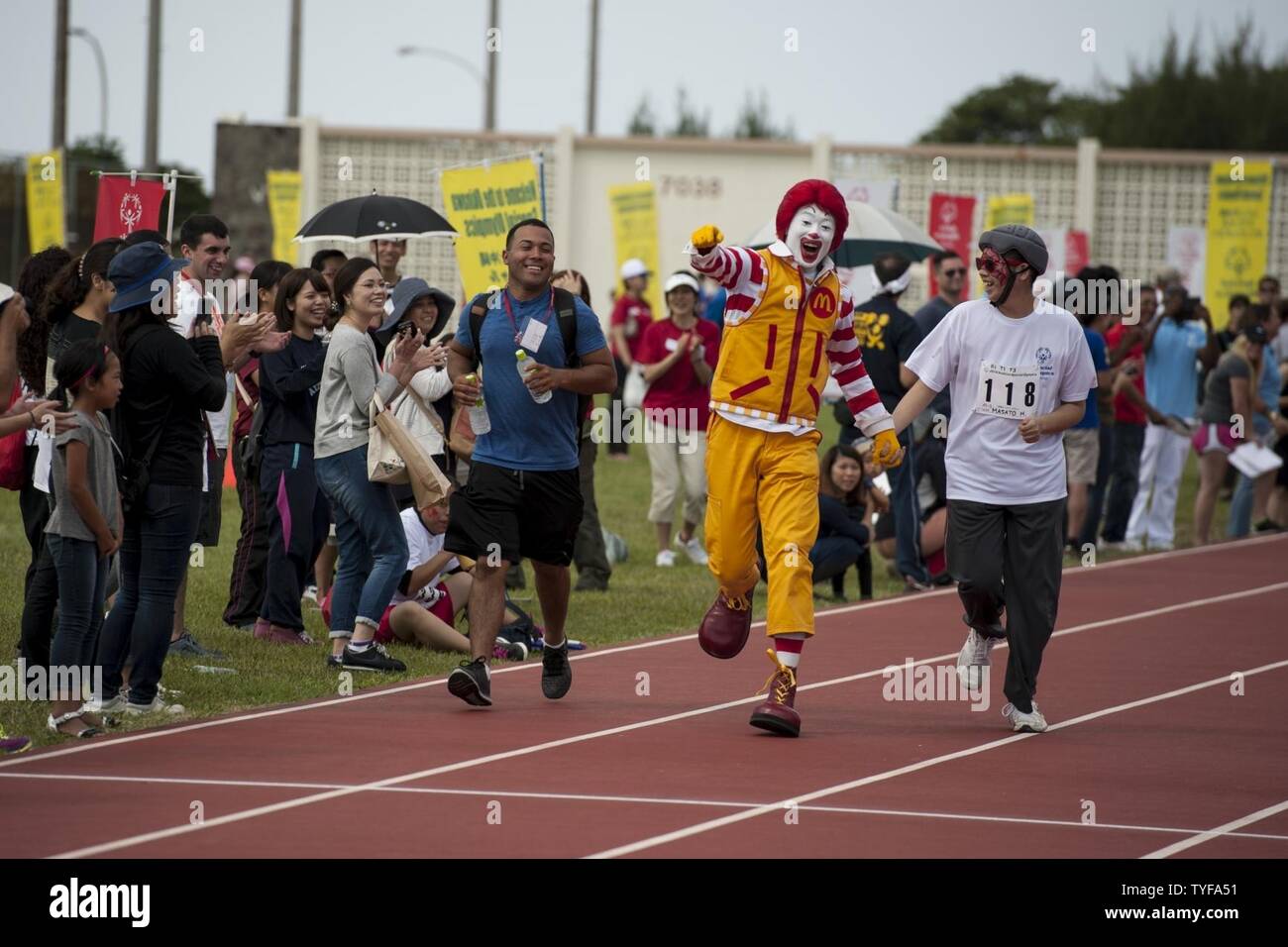 Brave Buddy volunteers run with Masato, a special-needs athlete, in a ...