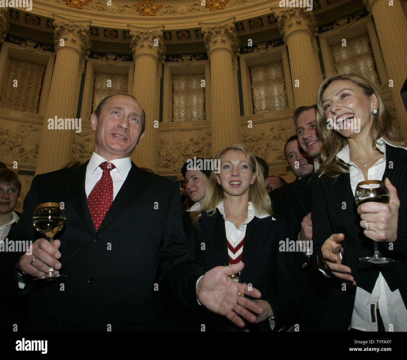 Russian President Vladimir Putin smiles during his meeting with members ...