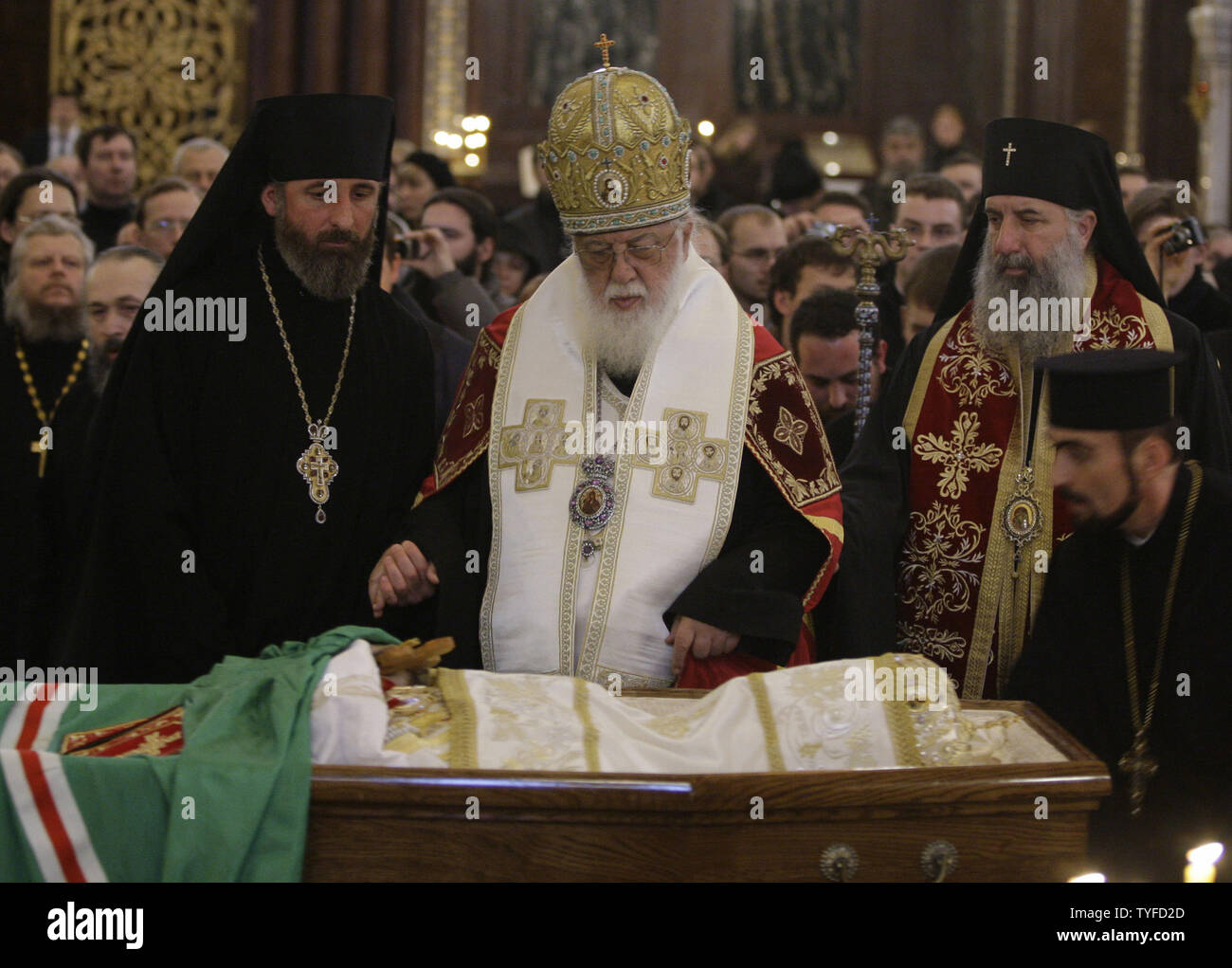 Georgian Catholicos-Patriarch Ilia II (C) mourns at a casket with late ...