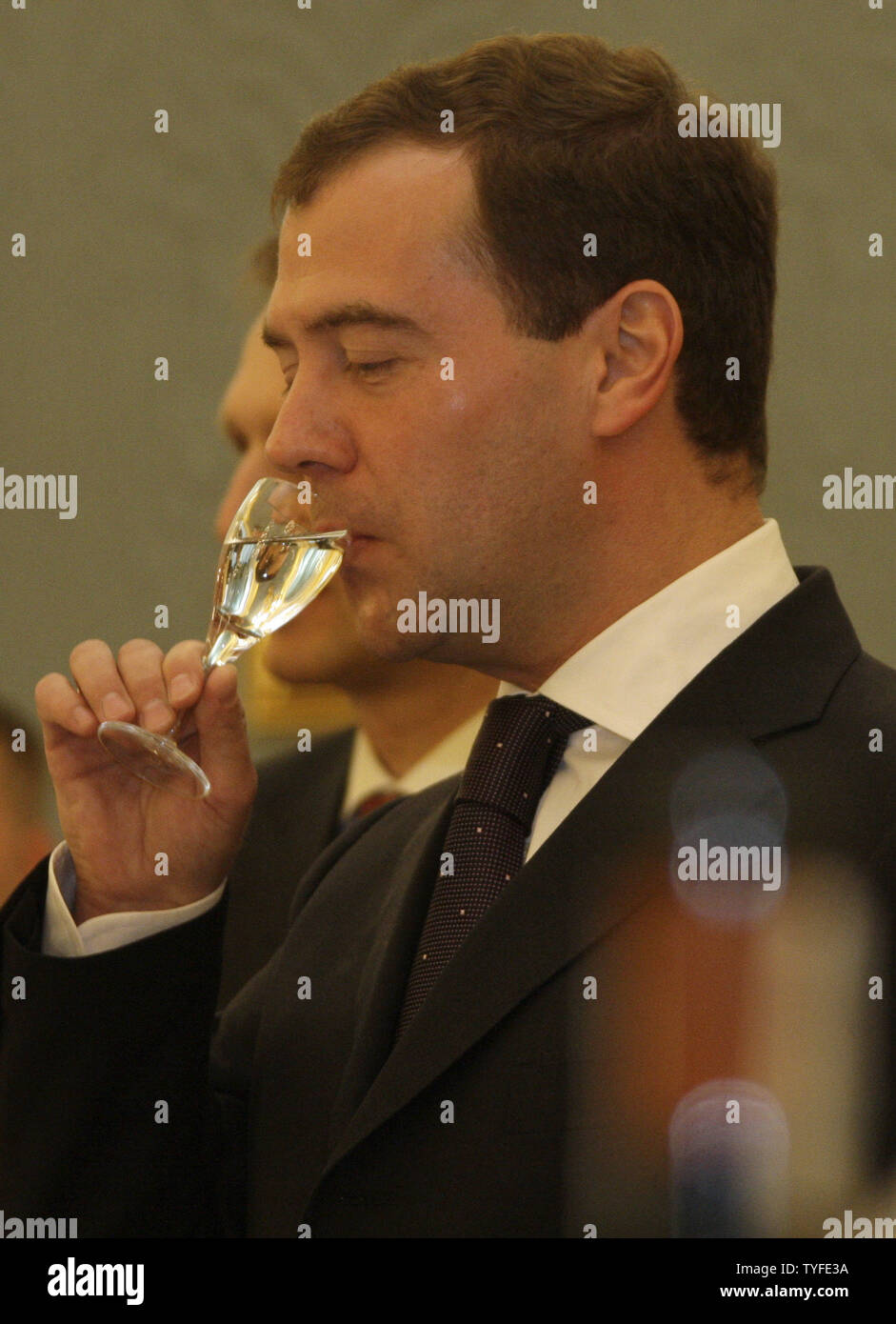 Russian President Dmitry Medvedev drinks a champagne during his meeting ...
