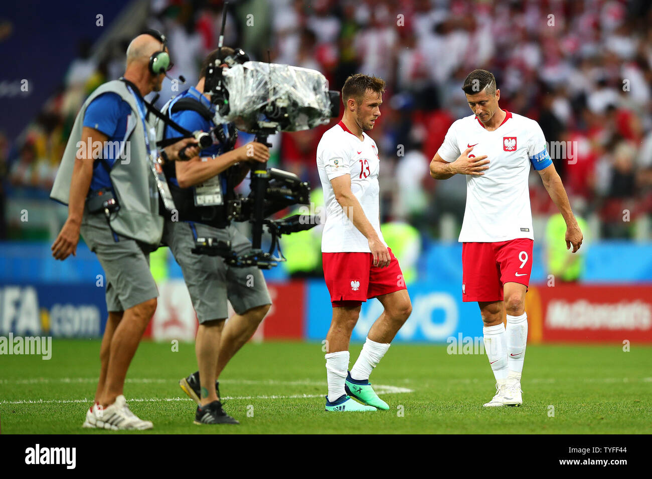 Robert Lewandowski (R) of Poland looks dejected at full-time following ...