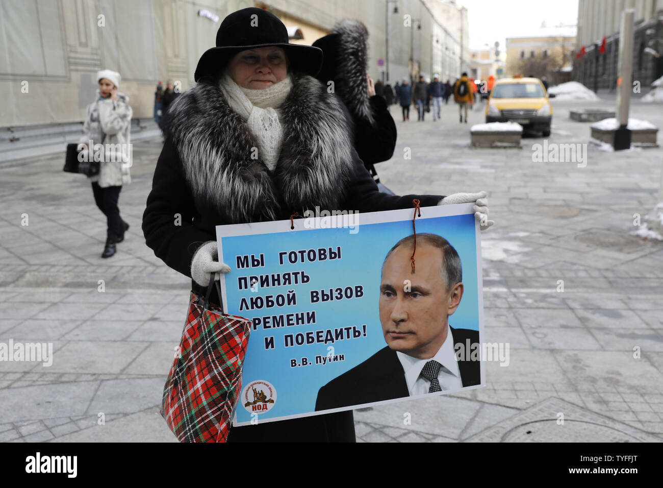 An activist from NOD political movement holds a poster of Russian ...