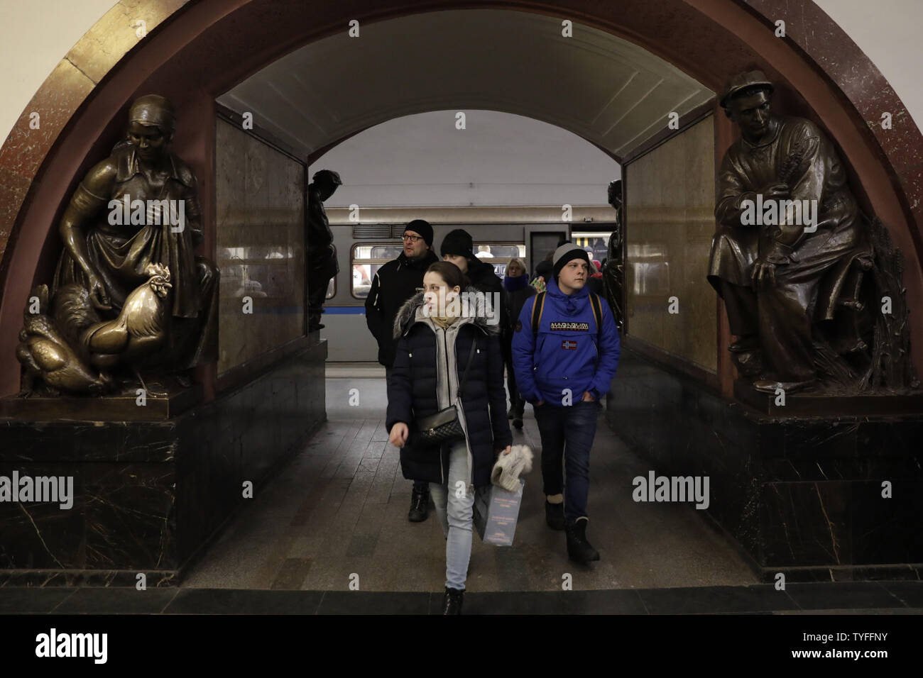 Passengers walk past Soviet era sculptures on the platform of Ploshchad ...