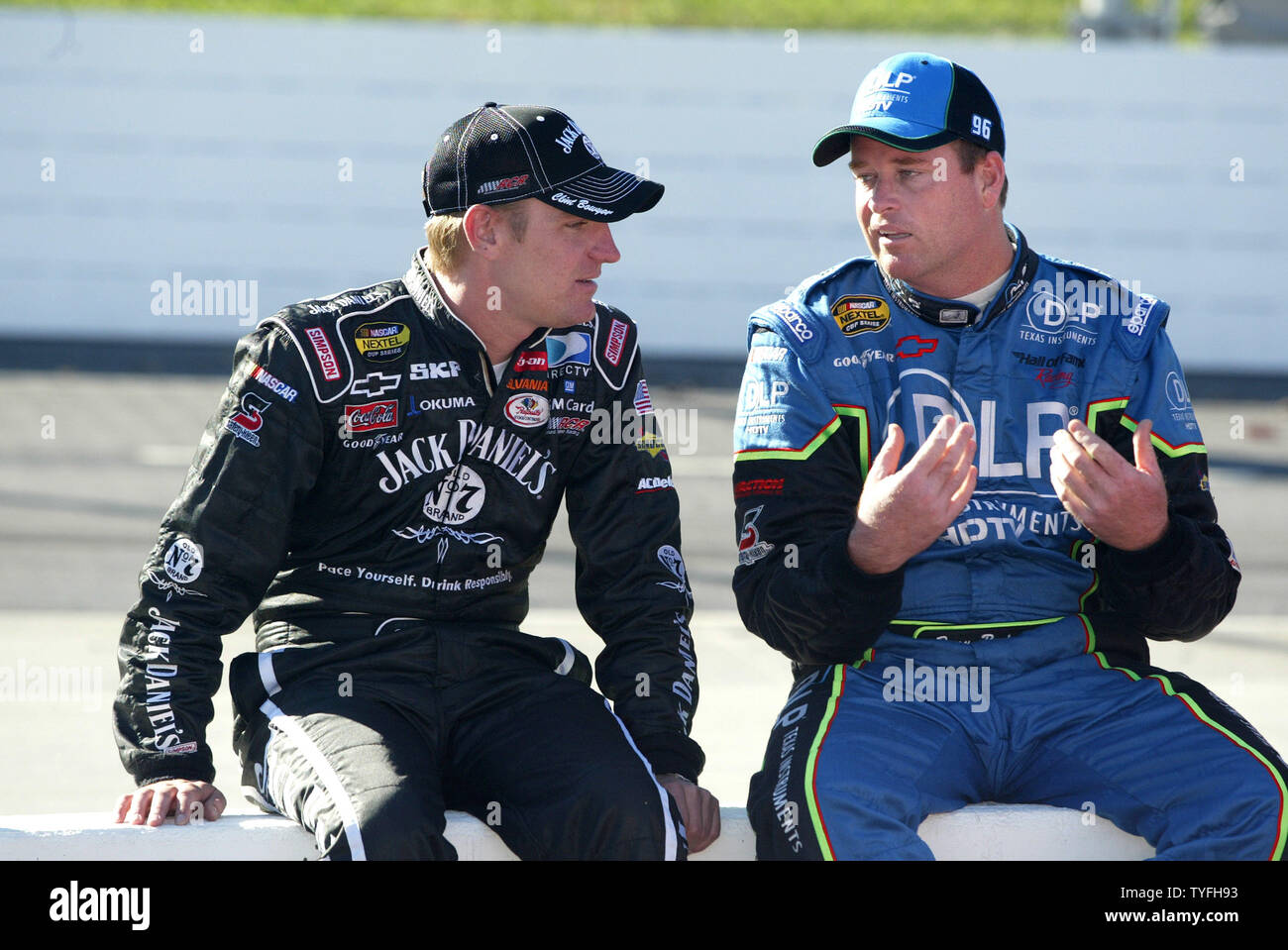 Race car drivers Clint Bowyer, left, and Tony Raines talk on pit road ...