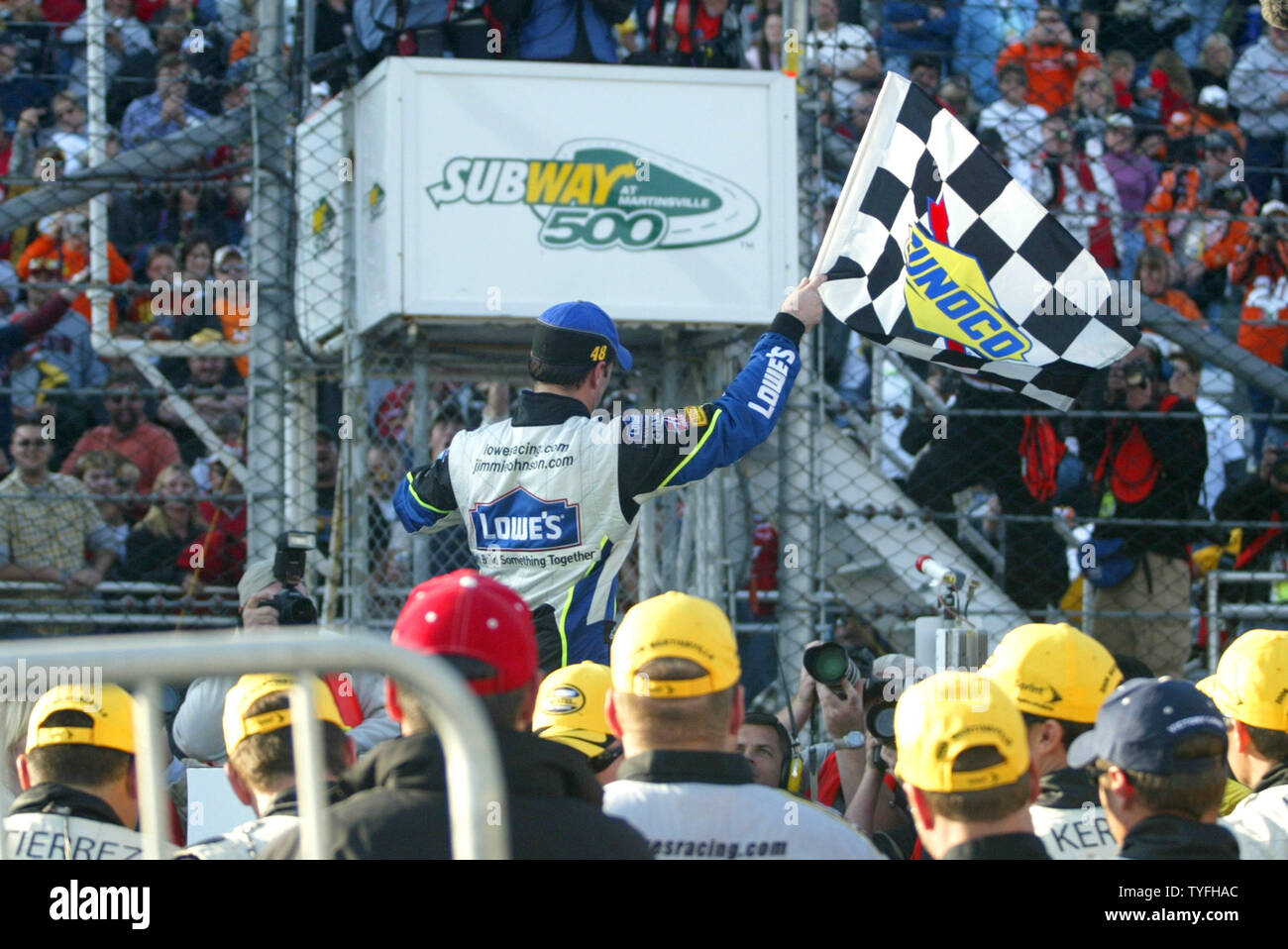 Jimmie Johnson waves the checkered flag as he celebrates his victory in ...