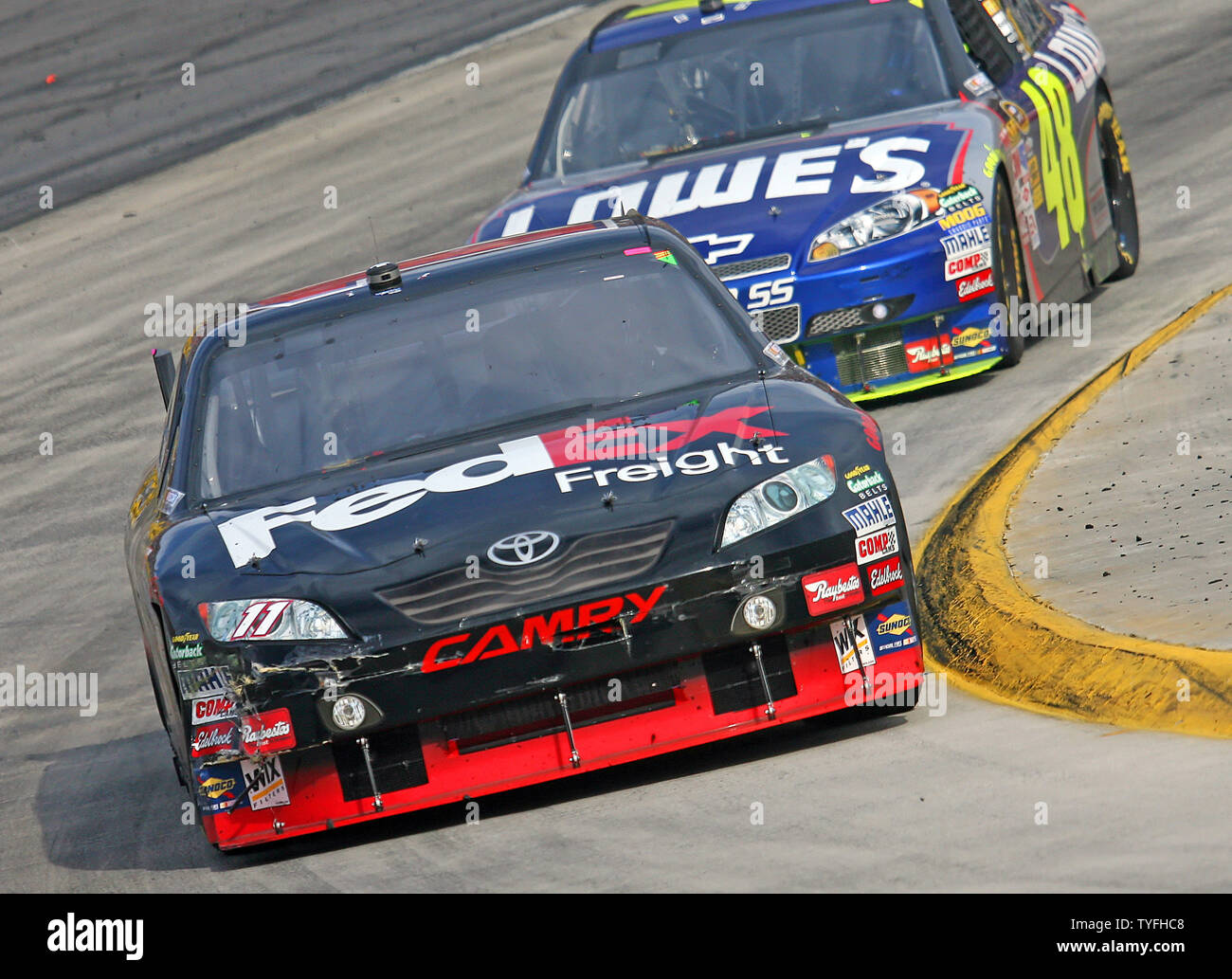 Denny Hamlin leads Jimmie Johnson out of turn four during the running ...
