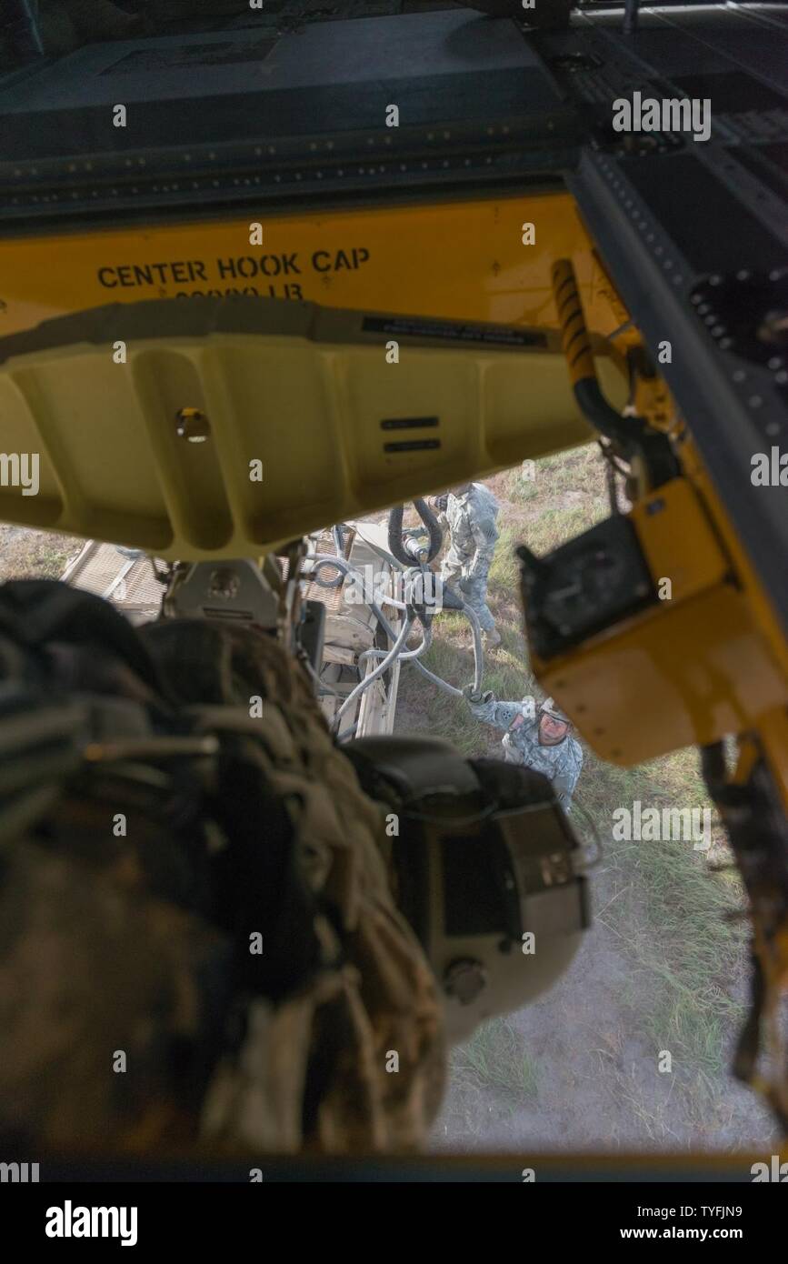Soldiers assigned to 3rd Division Artillery hook up a Humvee and ...