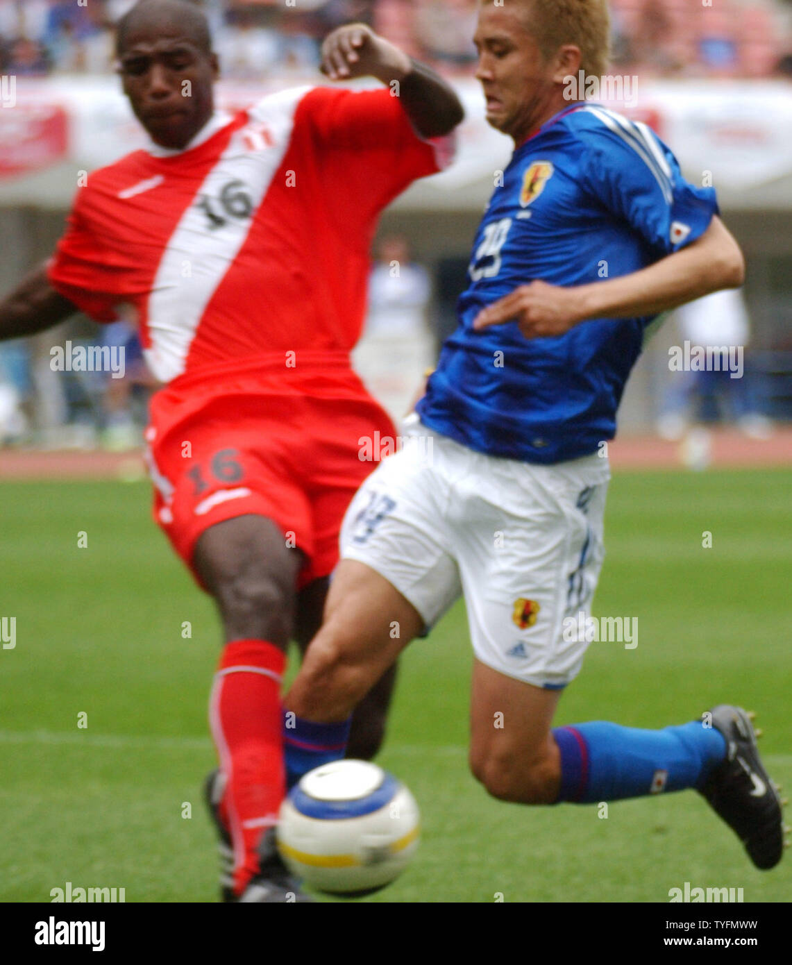 Junichi Inamoto (R) of the Japanese National Football Team dribbles a ...