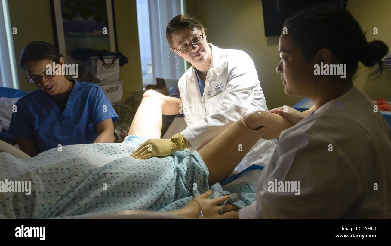 U.S. Navy Lt. Cmdr. Rozalyn Love, center, shows Lt. Jessica Dalrymple ...