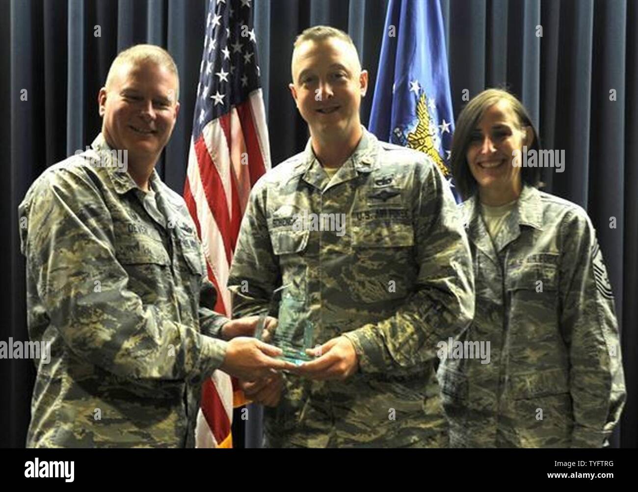 Col. James DeVere, 302nd Airlift Wing Commander, left, presents 2nd Lt ...