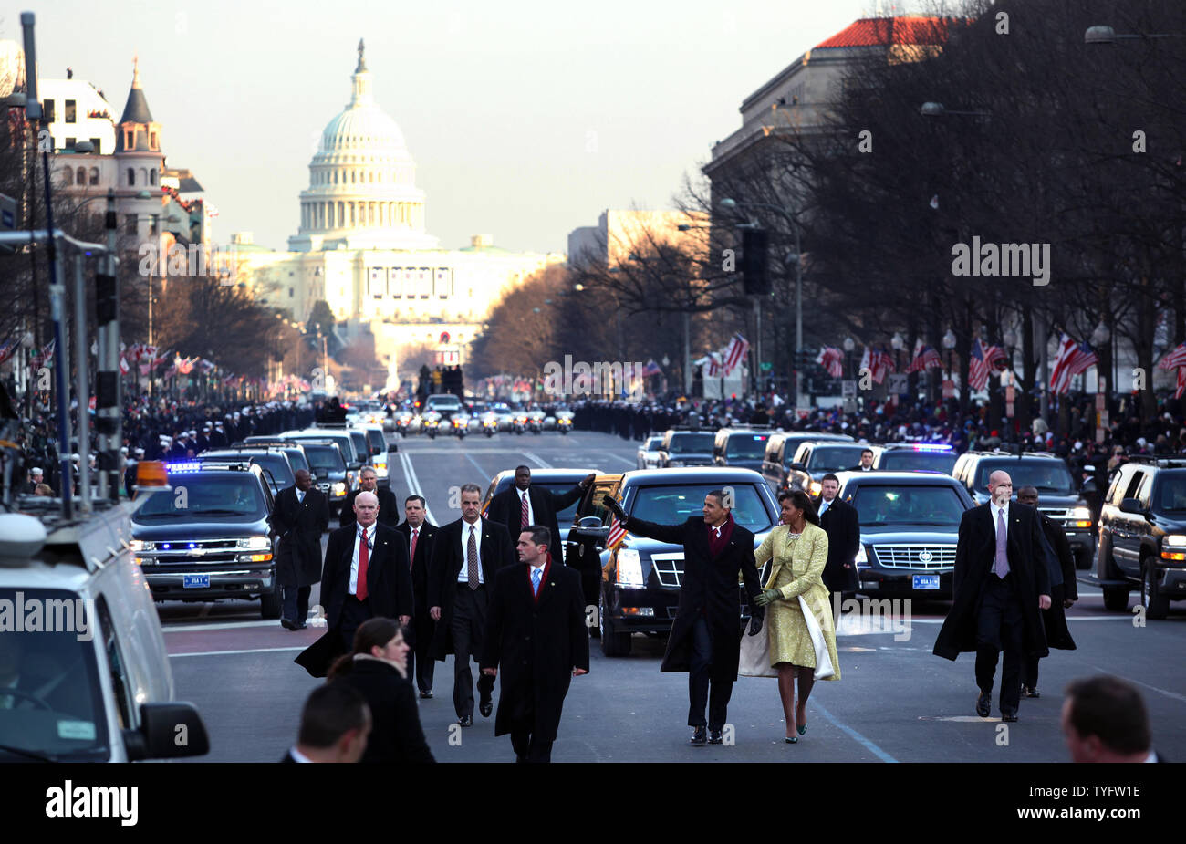 Barack and Michelle Obama wave while walking the parade route after the ...