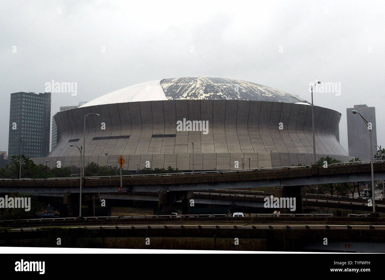 The Superdome roof is half stripped away after Hurricane Katrina slams ...