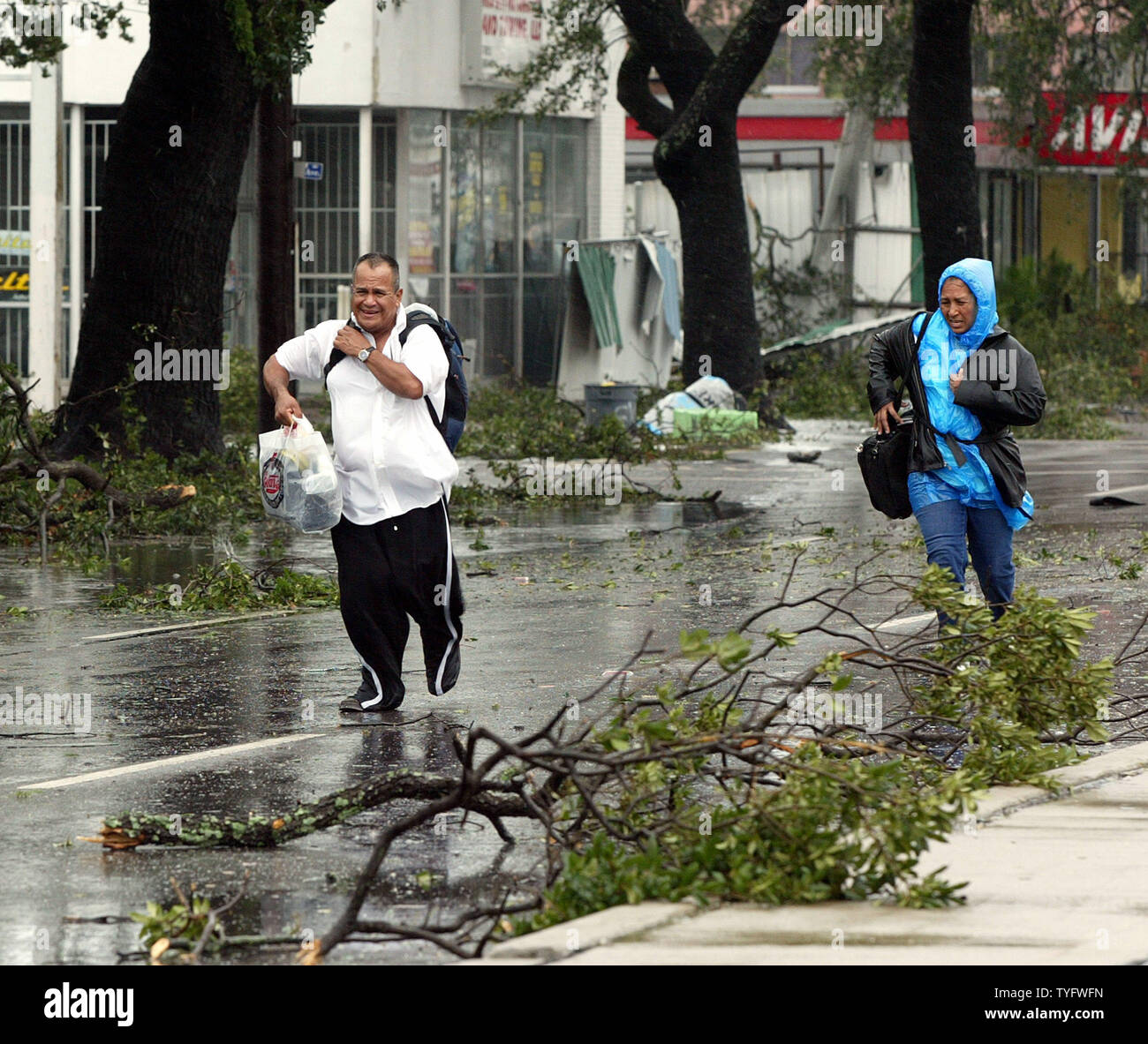 A couple runs down Canal Street in New Orleans as Hurricane Katrina ...