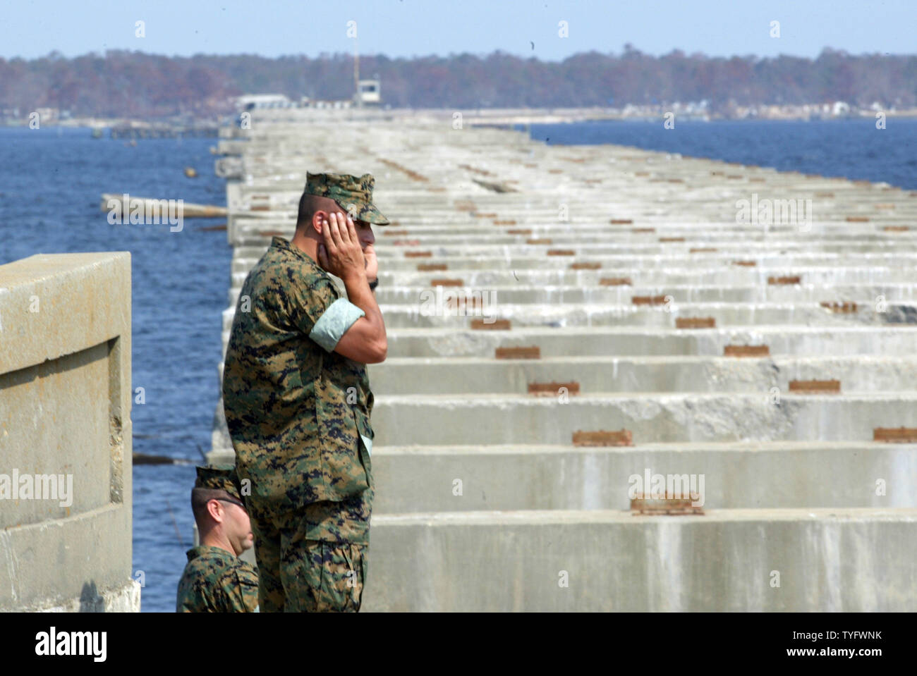 A U.S. Naval officer surveys damage to the Route 90 bridge in Bay St ...