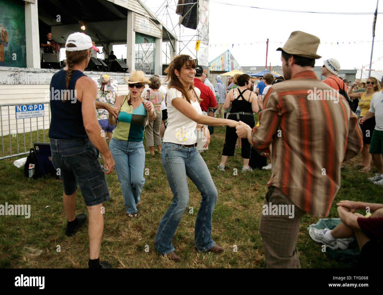 People dance to the Cajun music in front of the Fais Do Do stage at the ...