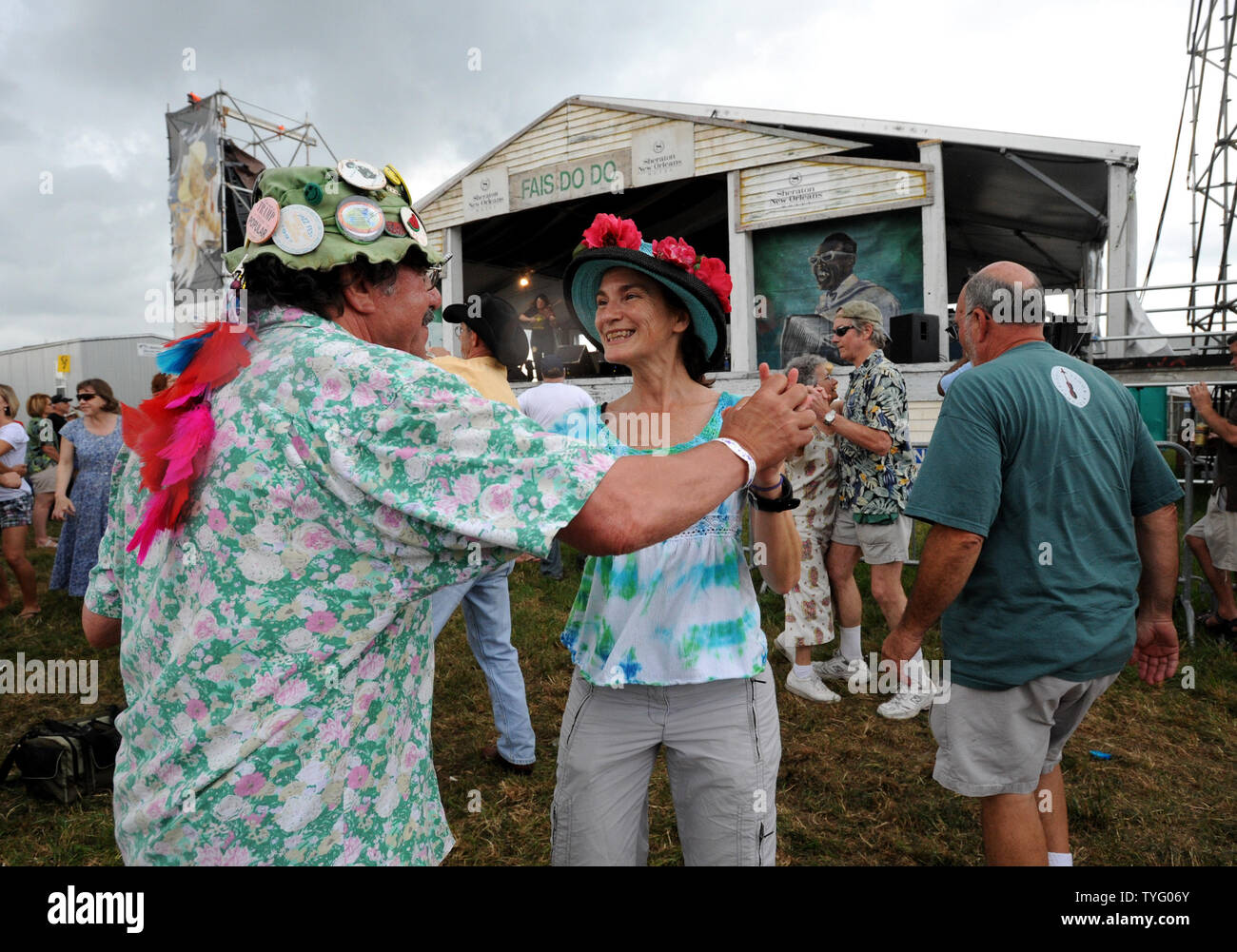 People dance to the Cajun music in front of the Fais Do Do stage at the ...