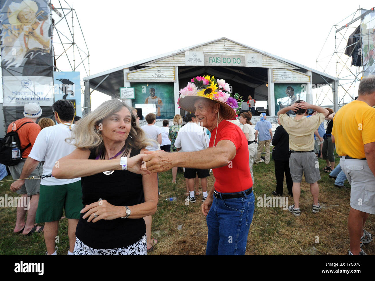 People dance to the Cajun music in front of the Fais Do Do stage at the ...