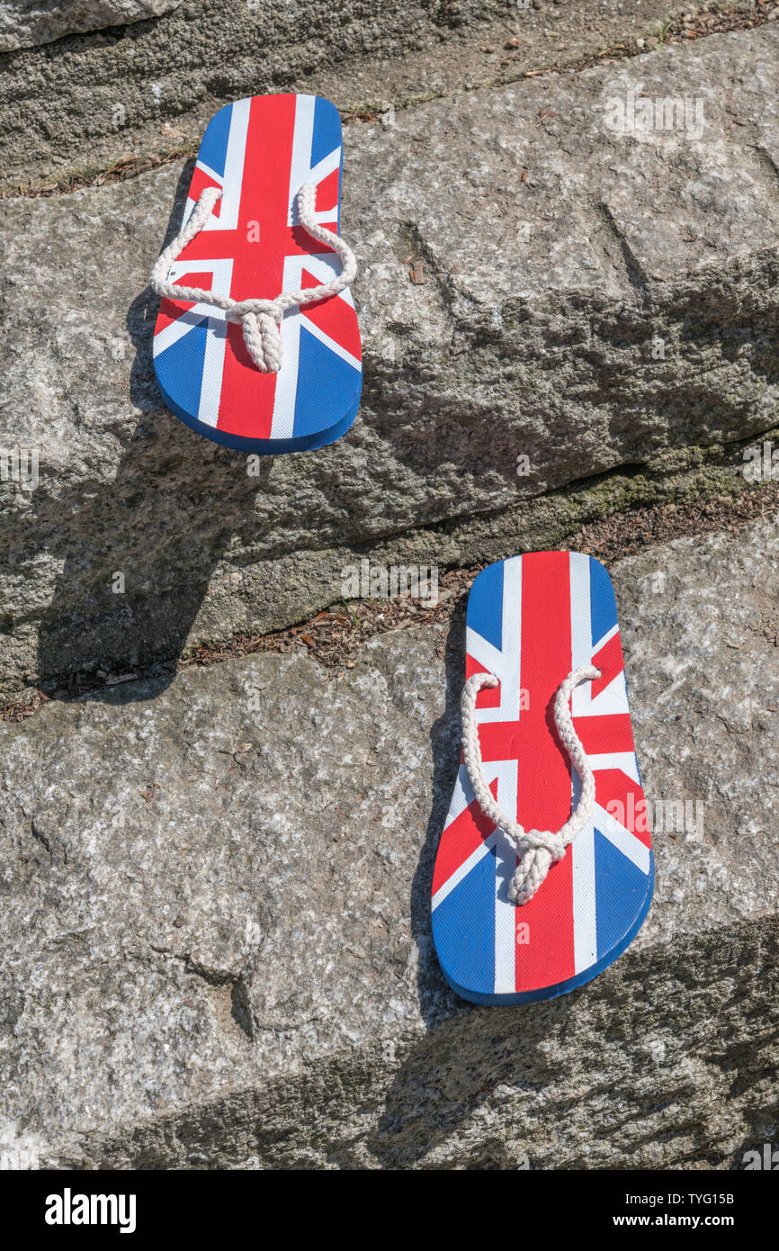 Union Jack flip-flops on edge of stone steps - for 2021 UK staycation ...