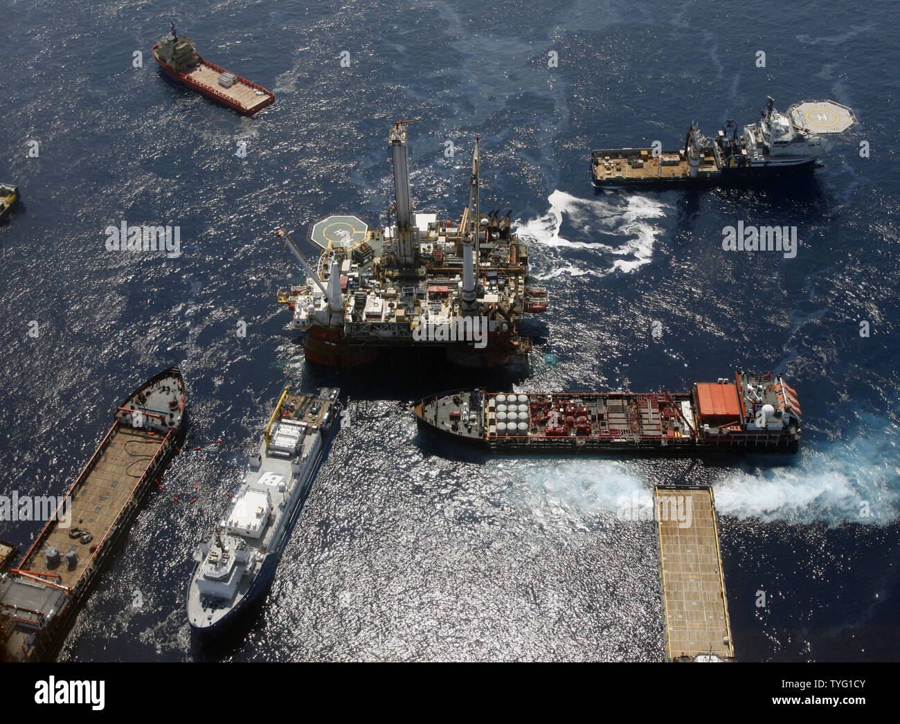 Work boats surround one of the rigs that is drilling a relief well at ...