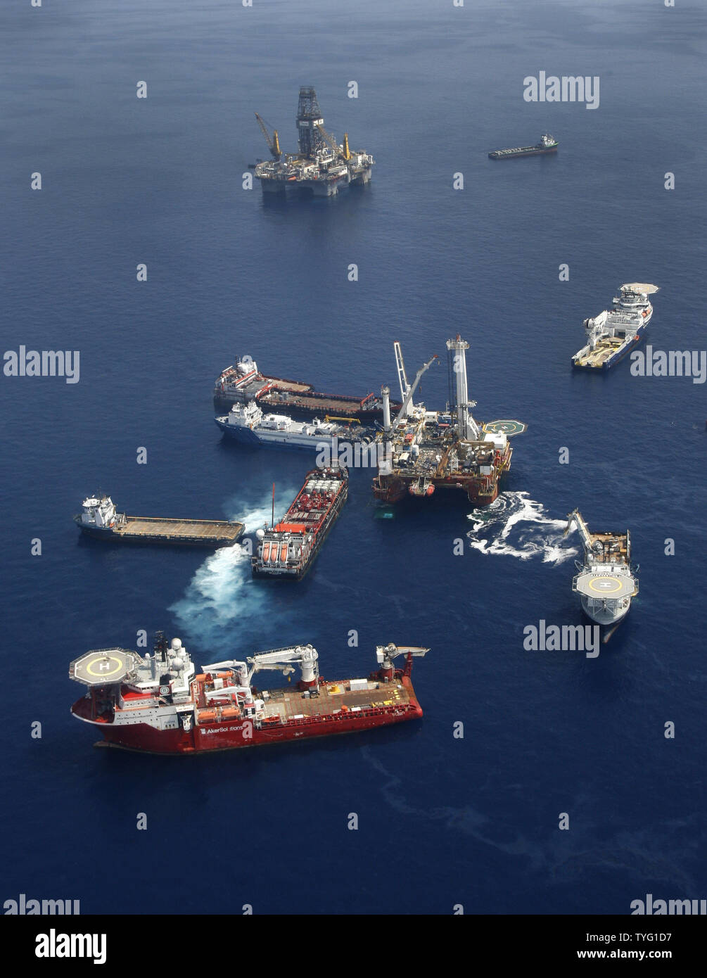 Work boats surround one of the rigs drilling a relief well at the site ...
