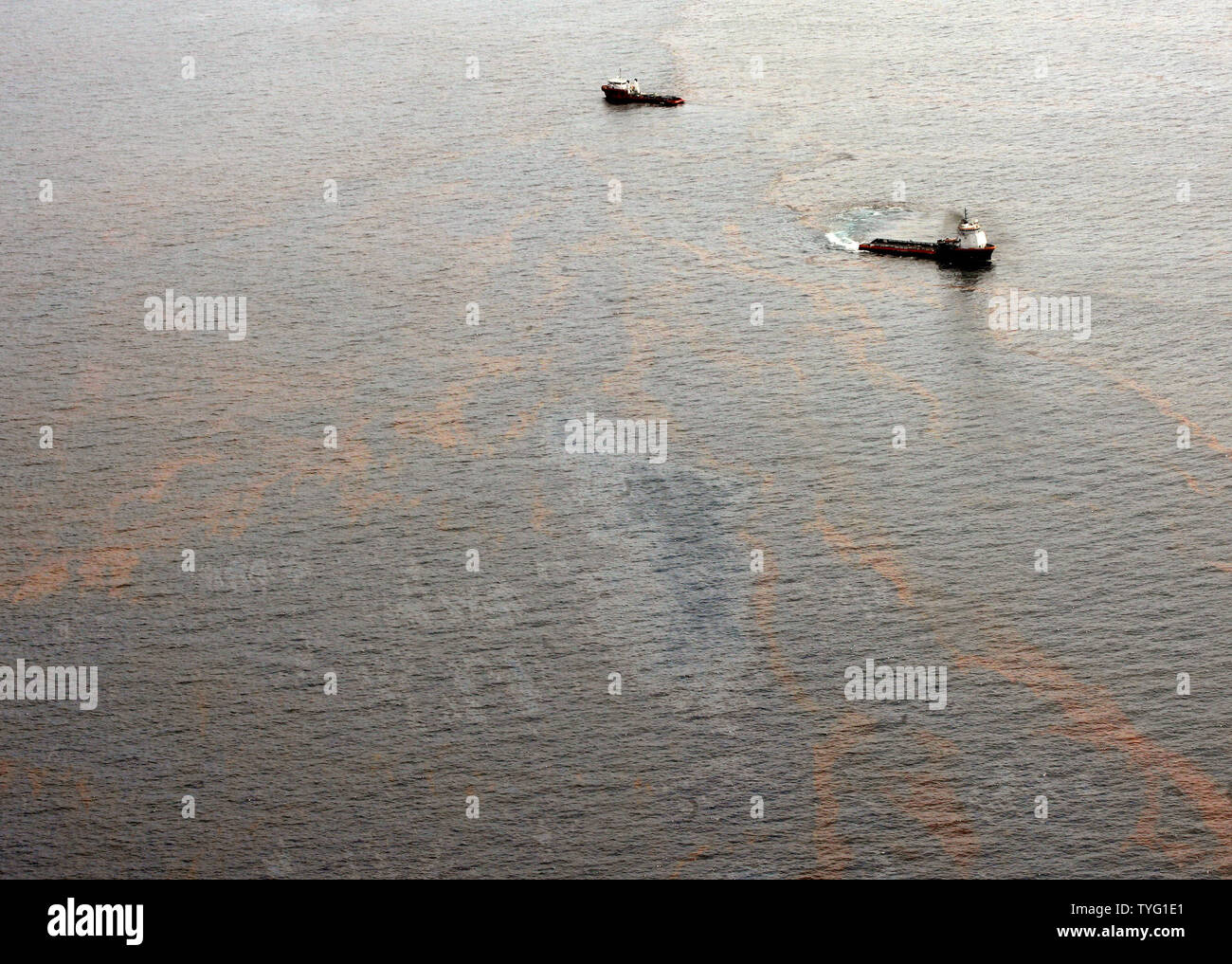 Boats plow through an oil slick in the Gulf of Mexico June 2, 2010. The ...