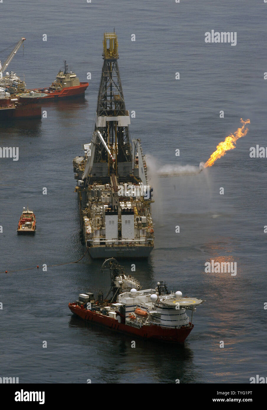 The Transocean Discoverer Enterprise drill ship (with flare) collects ...