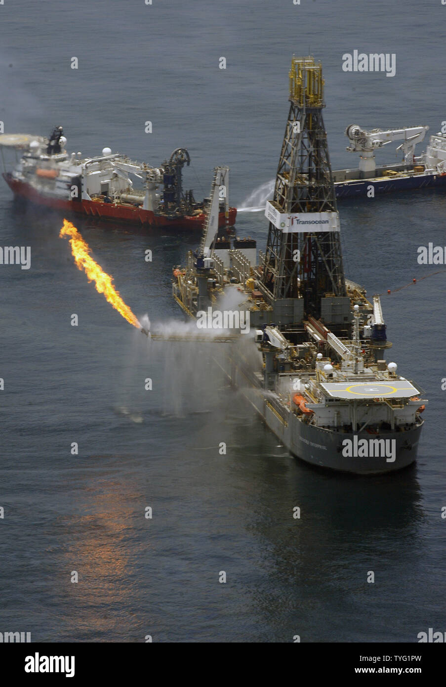 The Transocean Discoverer Enterprise drill ship (with flare) collects ...