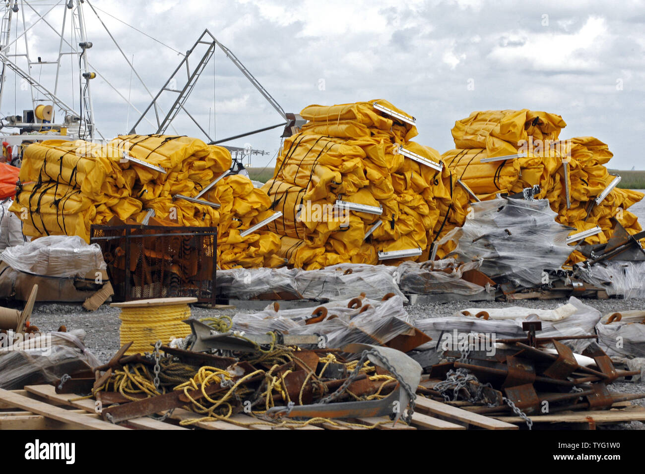 Oil containment booms sit on the dock of the BP staging area in ...
