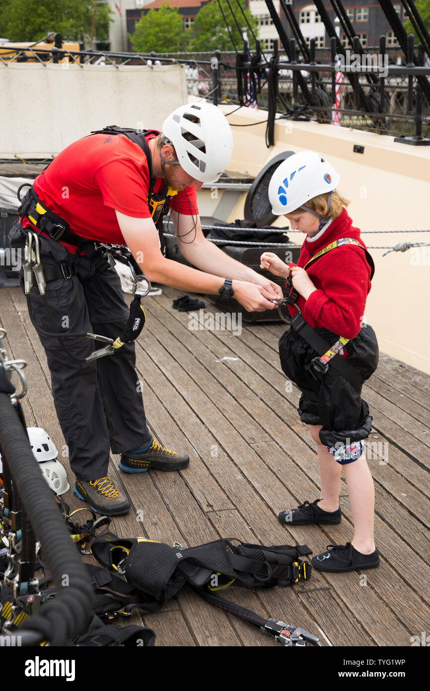 Instructor prepares girl / child / kid to climb the rigging of the SS ...