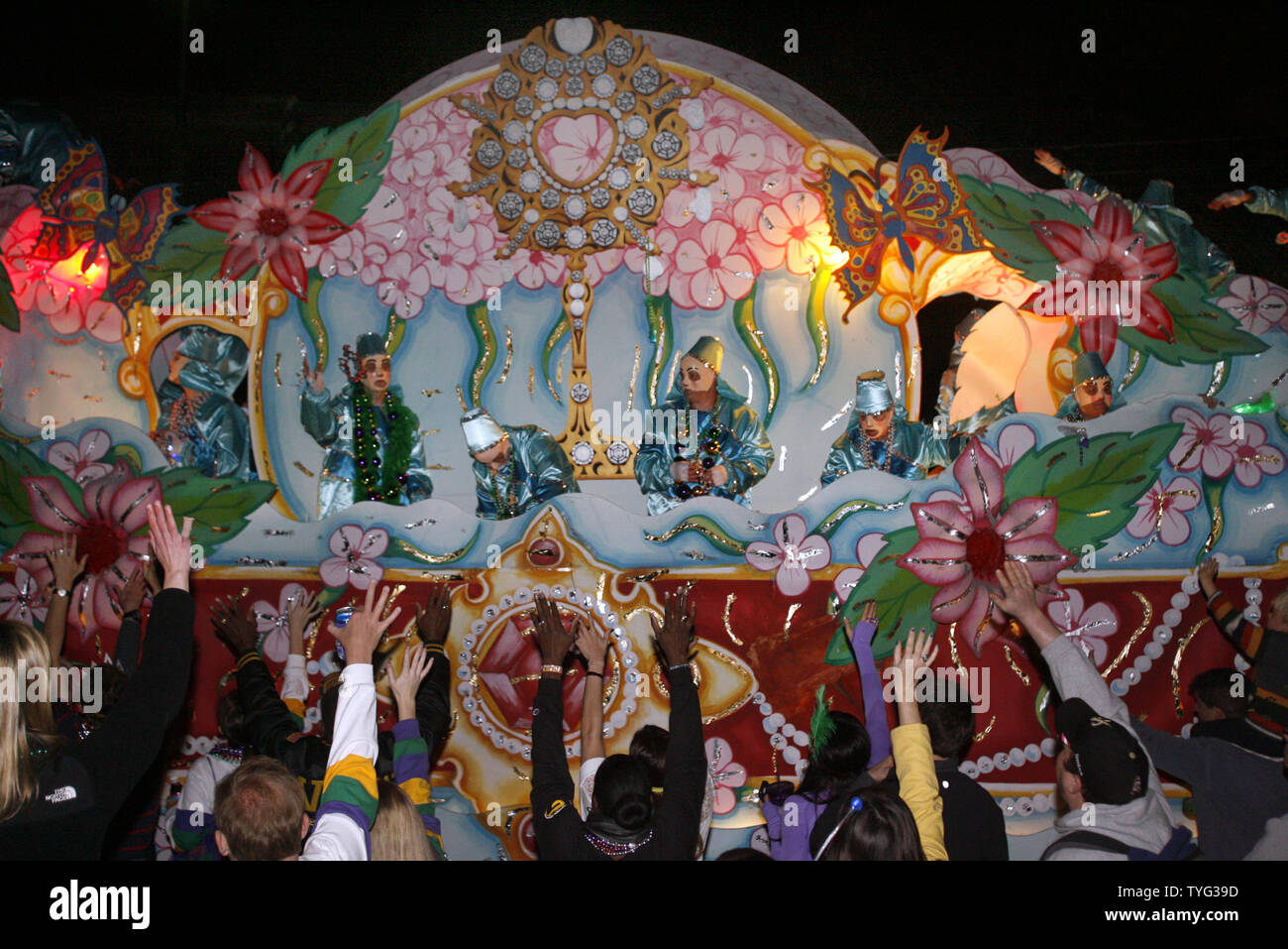 Crowds reach for beads during the Krewe of Hermes parade as it rolls ...