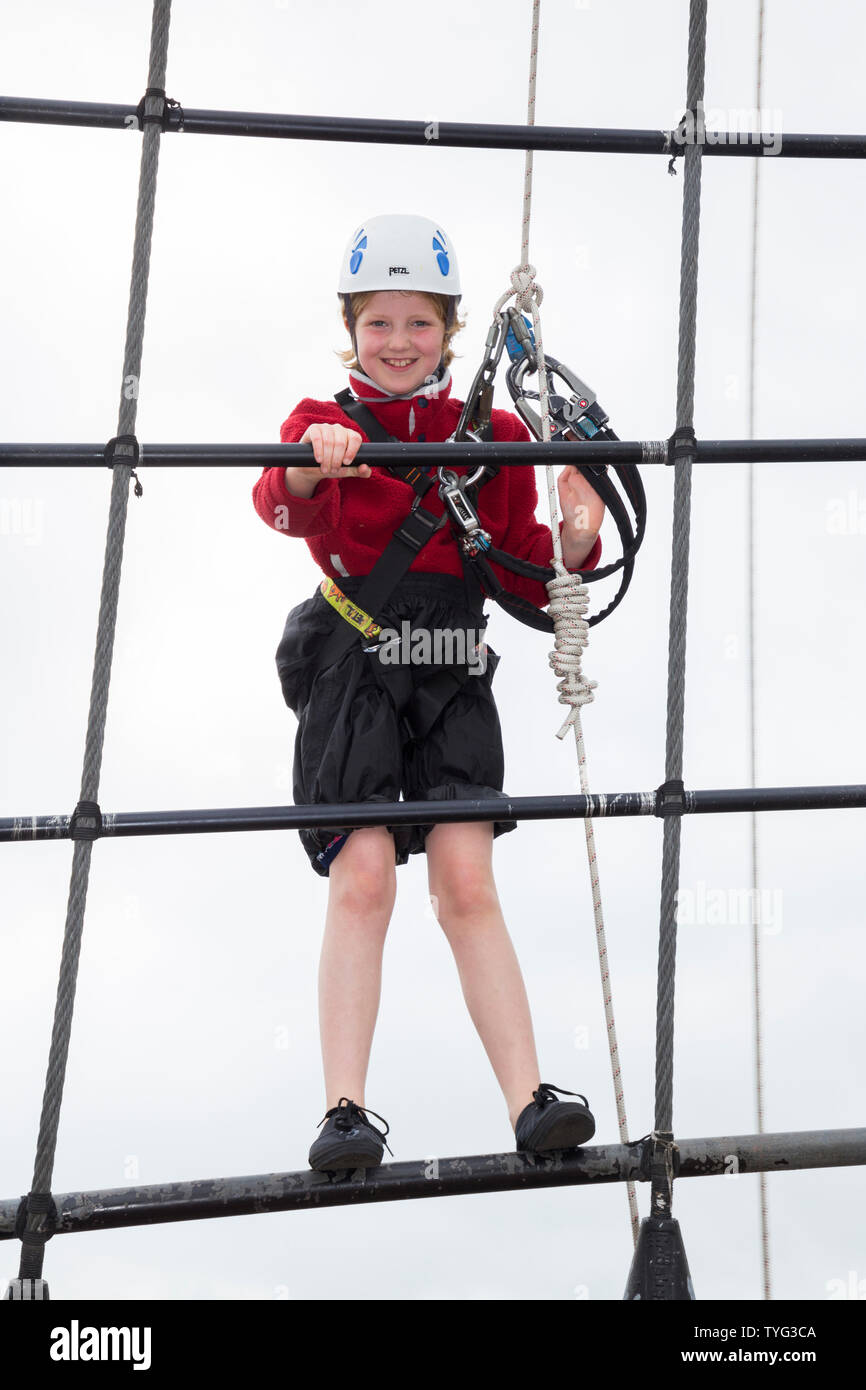 Girl / child / kid climbs / climbing the rigging and ropes of the SS ...