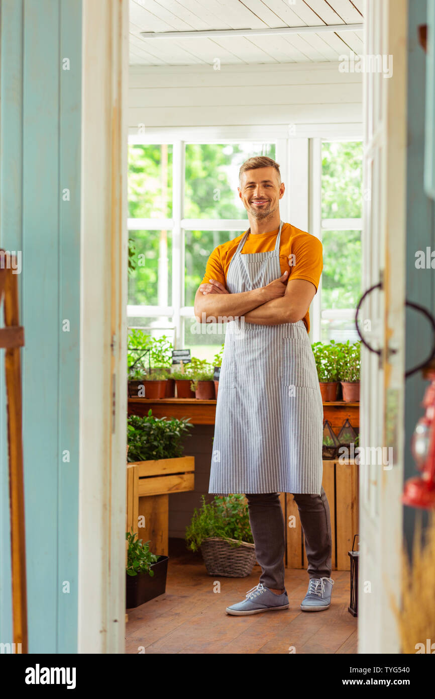 Flower shop seller smiling to his customers Stock Photo - Alamy